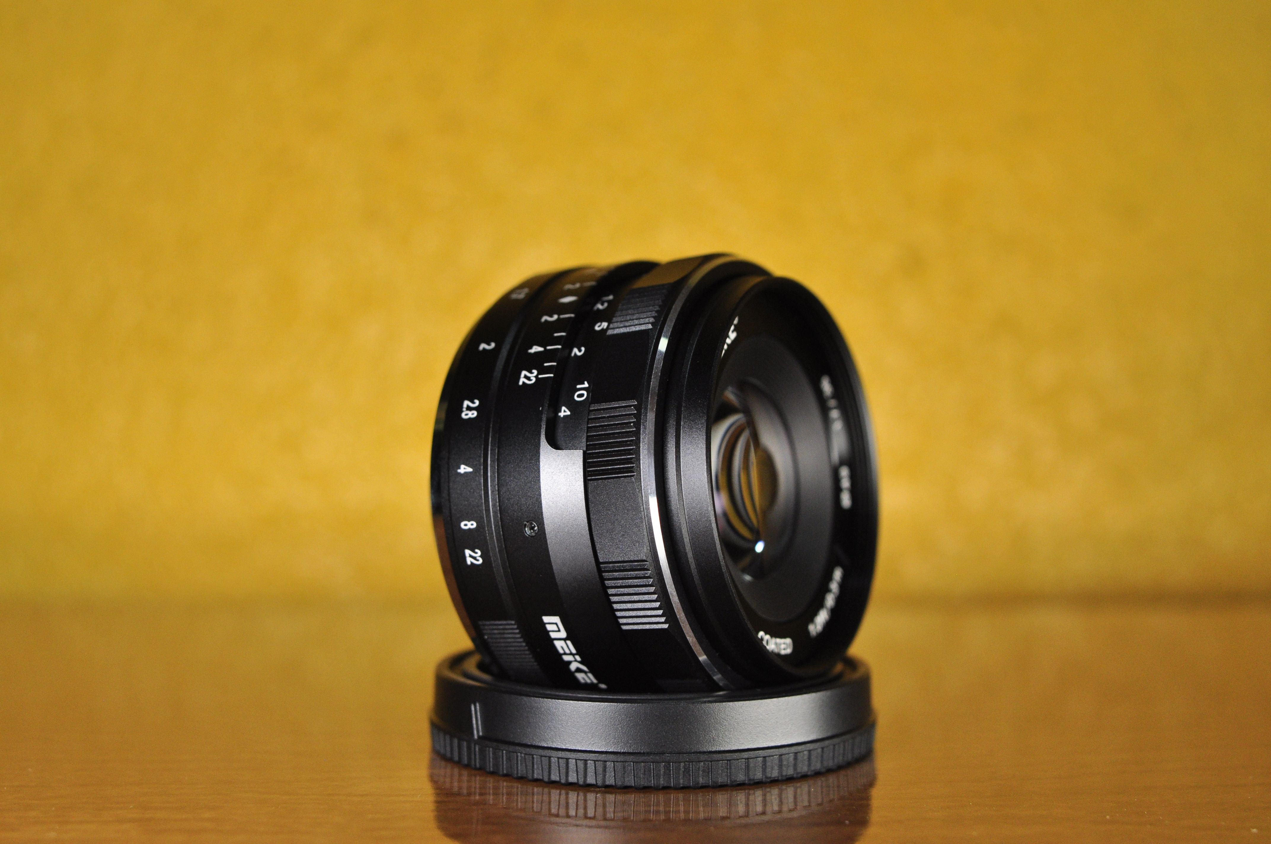 Close-Up Shot of Camera Lens on Yellow Background · Free Stock Photo