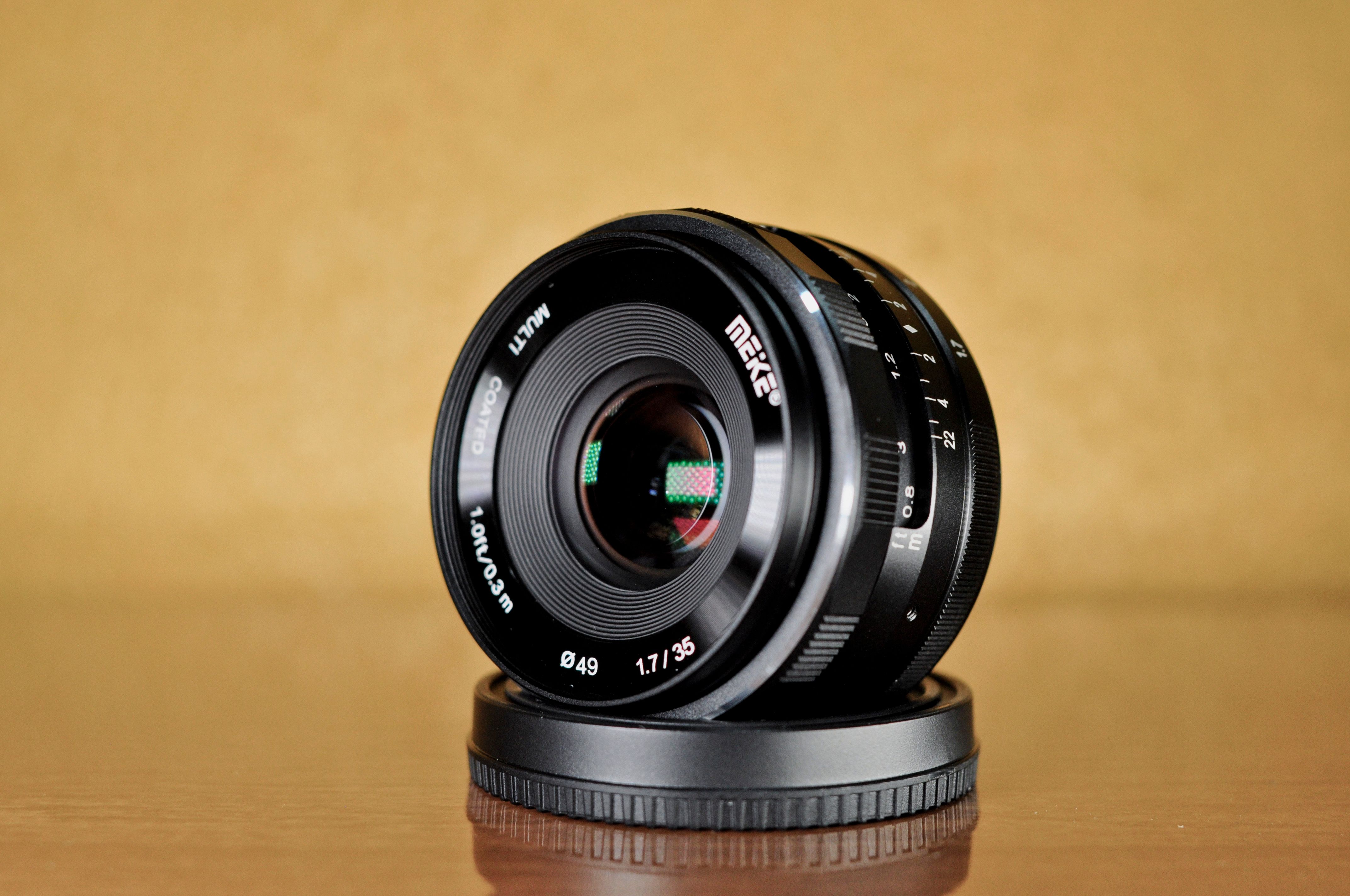 Close-up of Meike 35mm Camera Lens on Table · Free Stock Photo