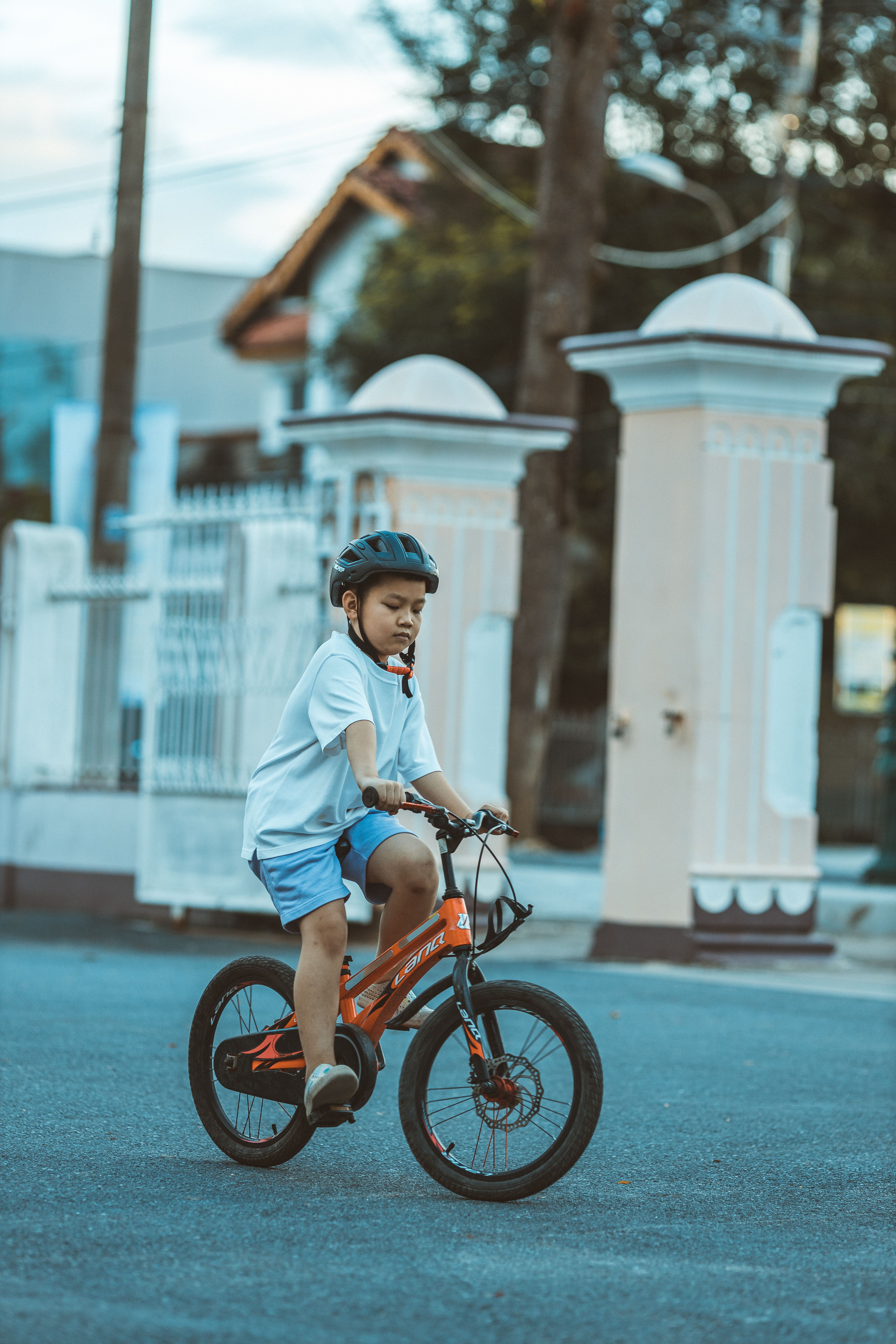 Young Boy Cycling Outdoors in Urban Setting · Free Stock Photo