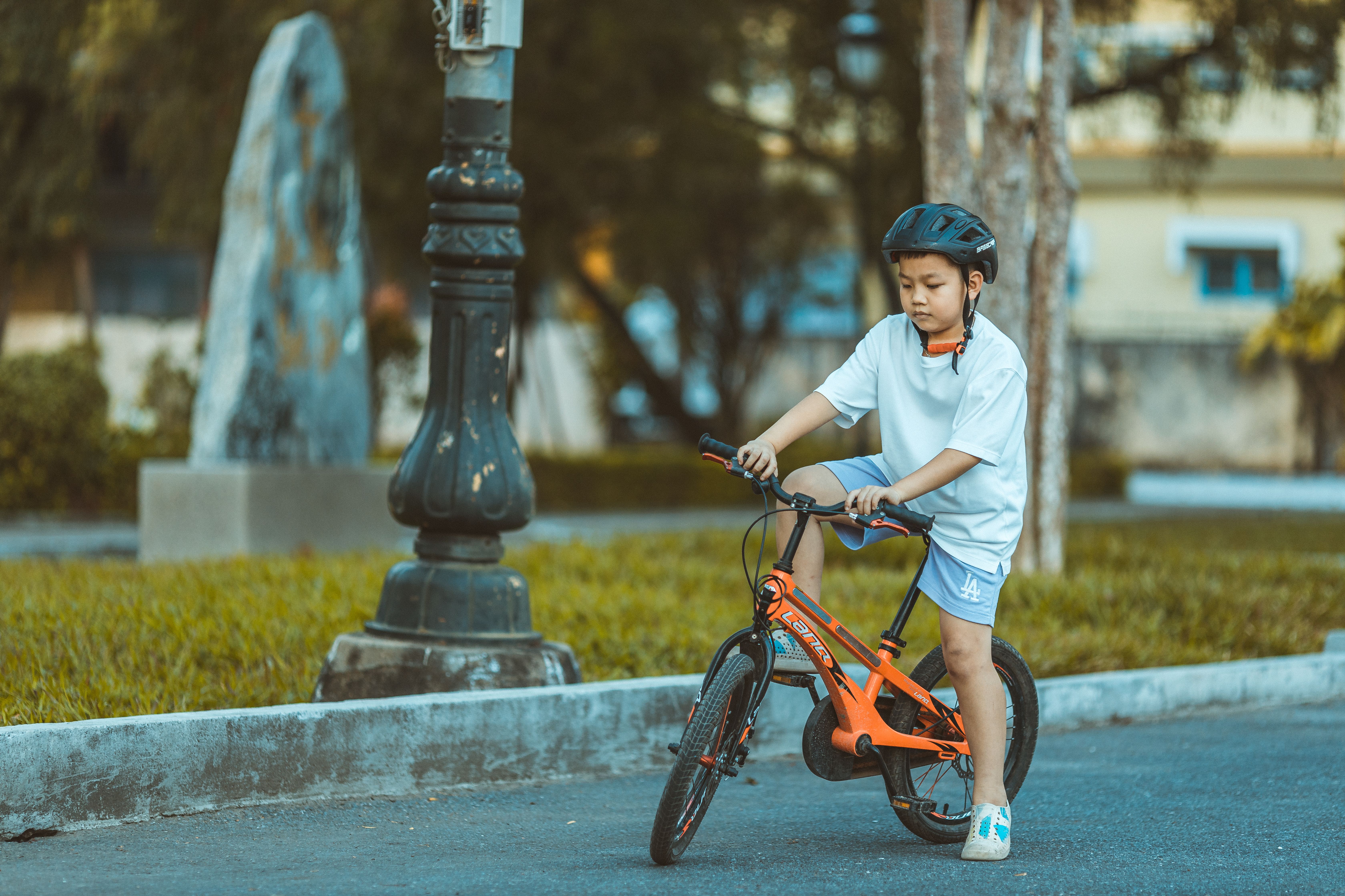 Child Riding Bicycle in Urban Park Setting · Free Stock Photo