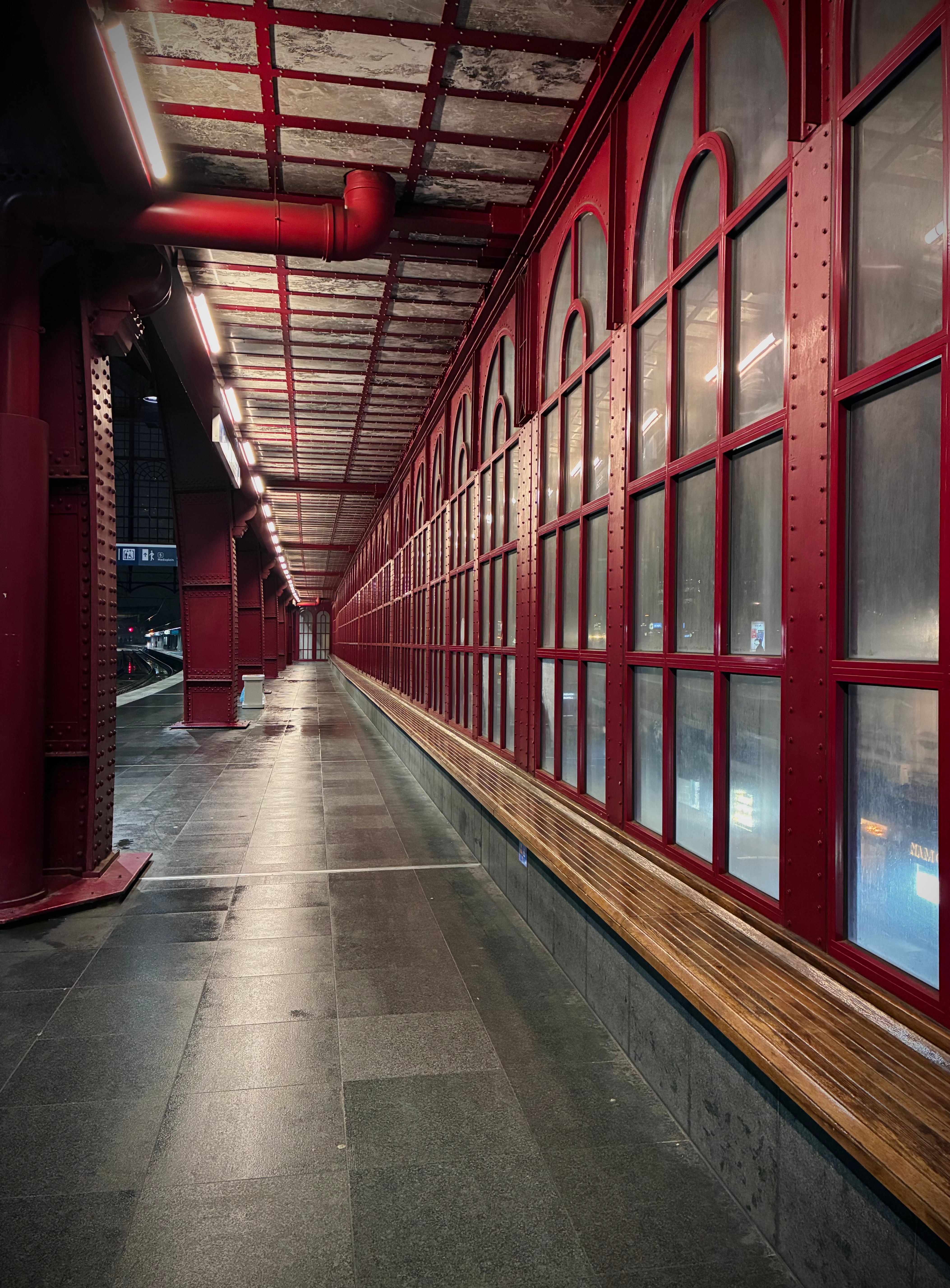 Red Steel Train Station Corridor with Arched Windows · Free Stock Photo