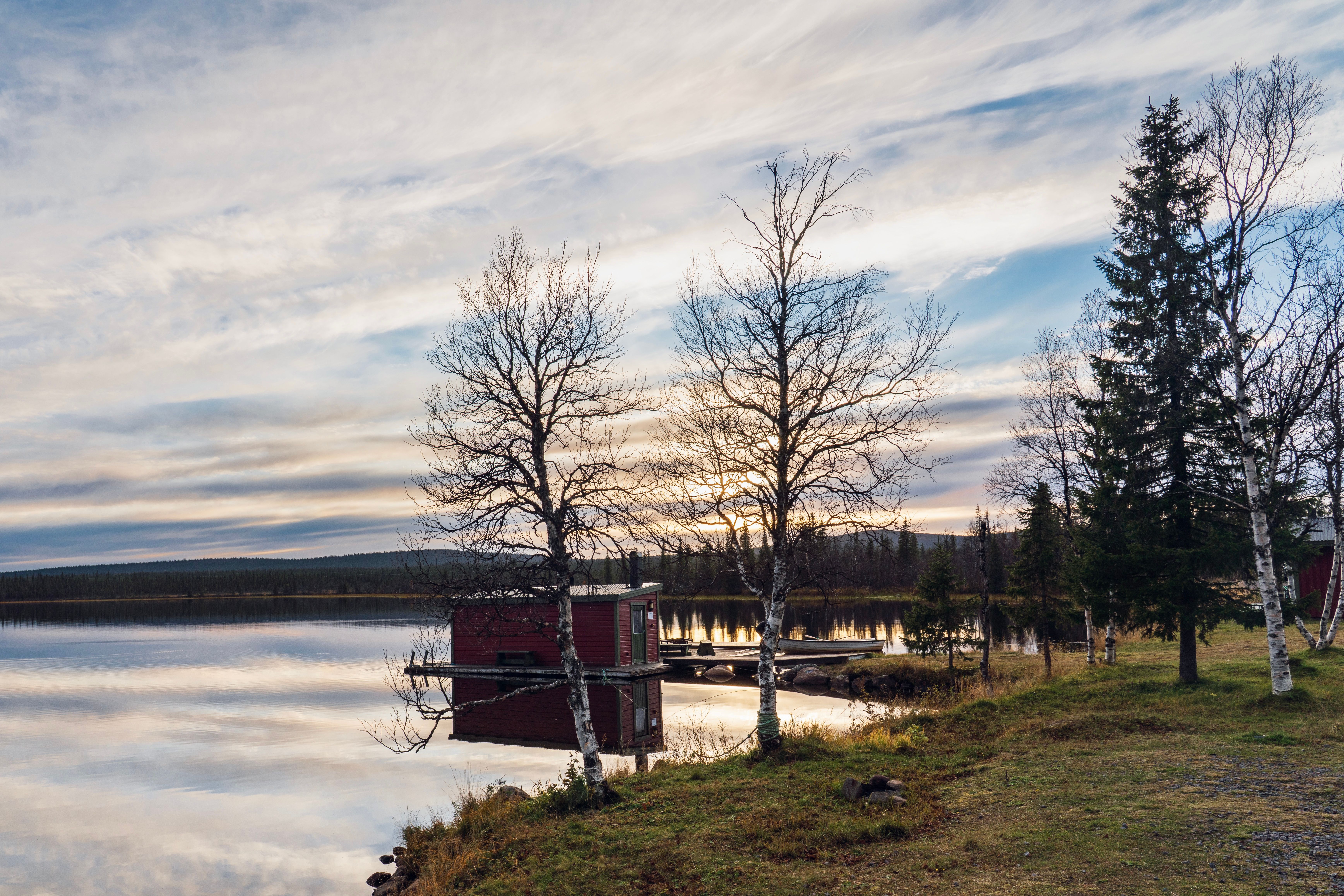 Scenic Lakeside View with Rustic Cabin at Sunrise · Free Stock Photo