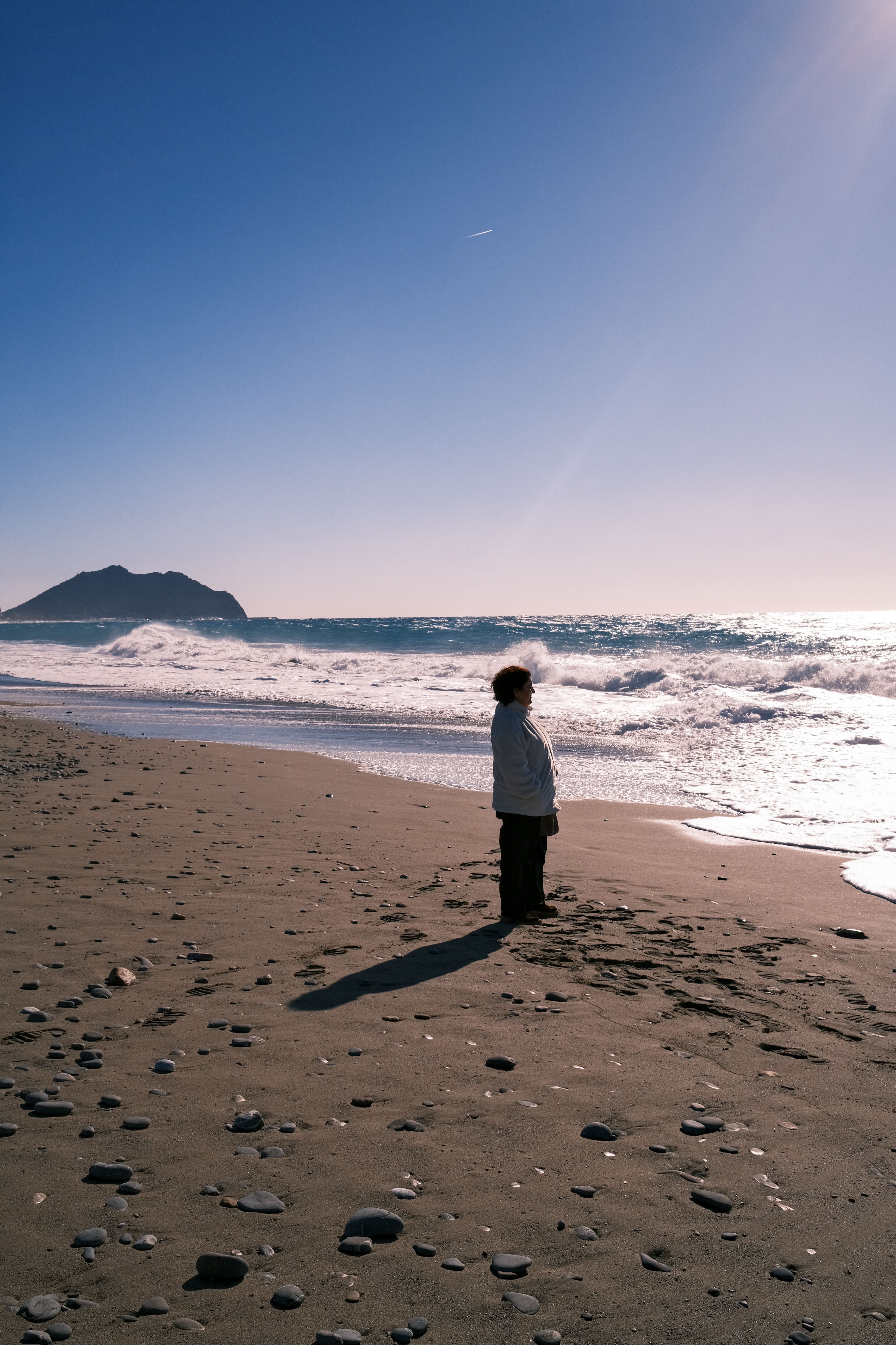 Child Contemplating on a Serene Beach at Day · Free Stock Photo