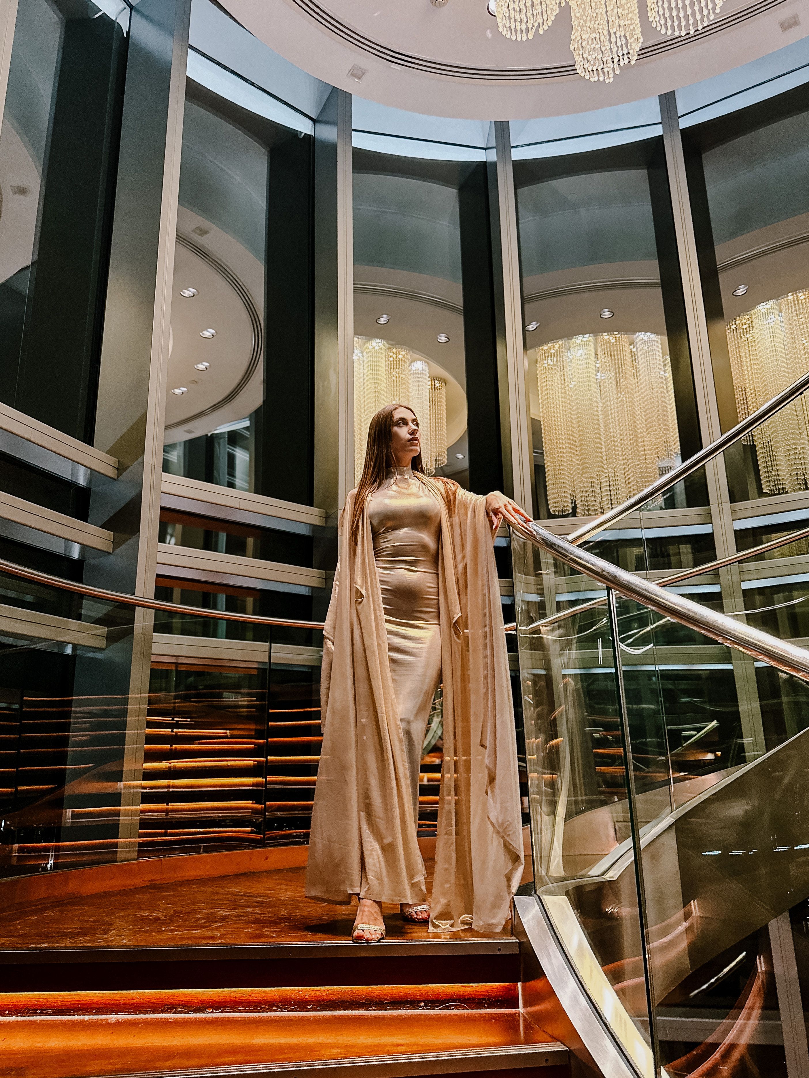 Elegant Woman Posing on Luxury Staircase Indoors · Free Stock Photo