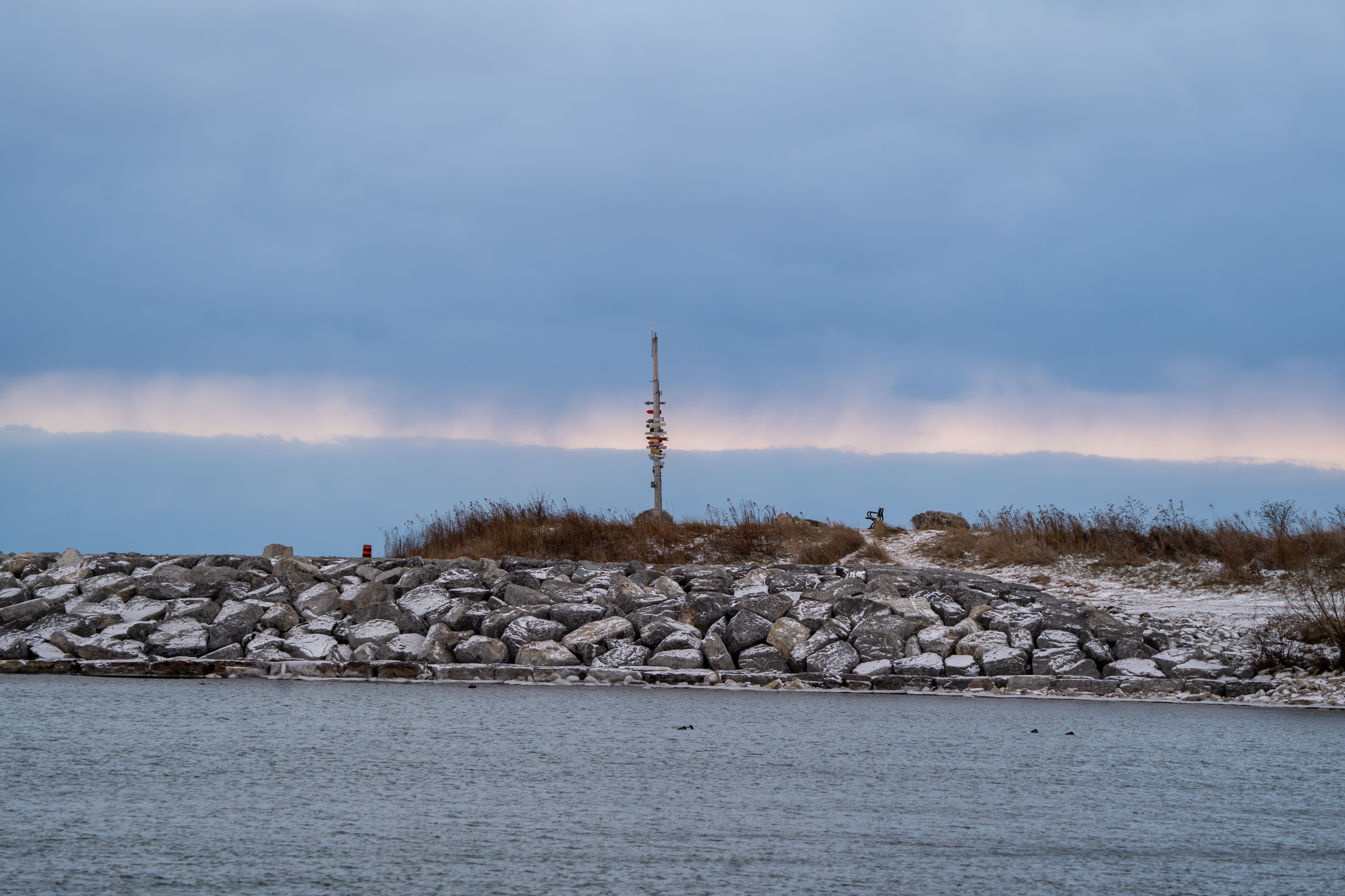Rocky Shoreline with Overcast Sky and Stack · Free Stock Photo