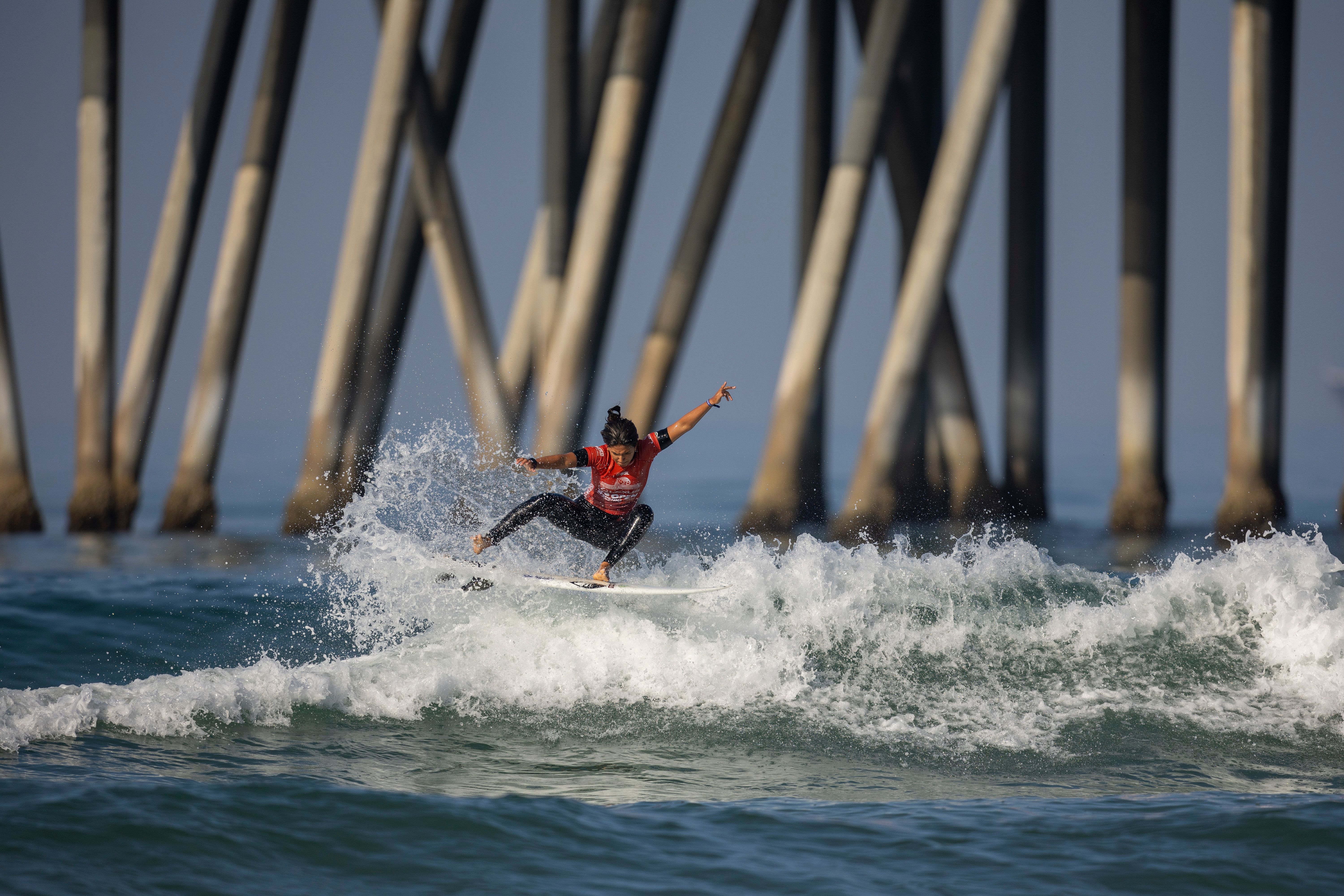 Dynamic Surfing Action near Ocean Pier · Free Stock Photo