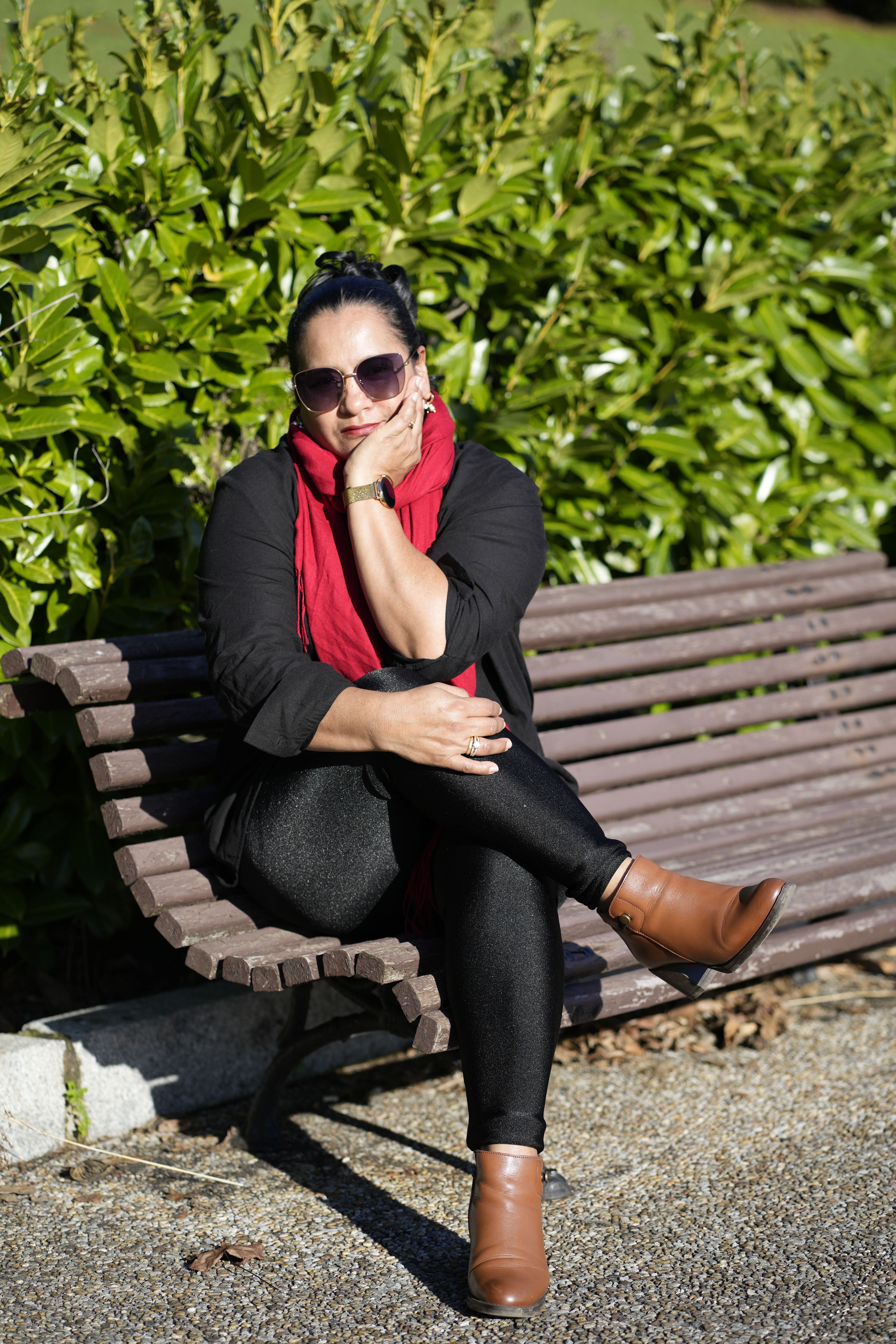 Woman Relaxing on Park Bench in Autumn Sun · Free Stock Photo