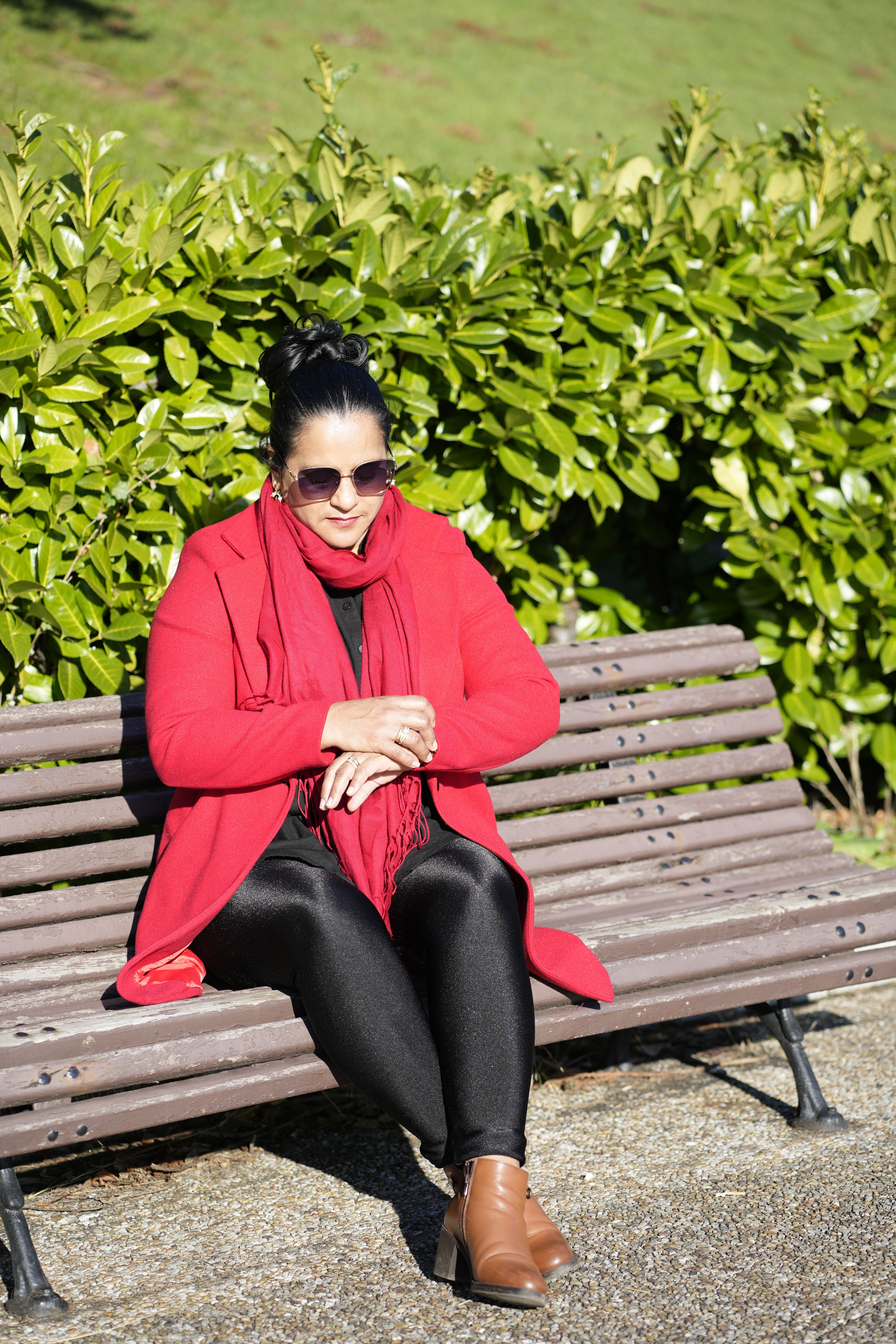 Woman Relaxing on Park Bench in Autumn Sun · Free Stock Photo