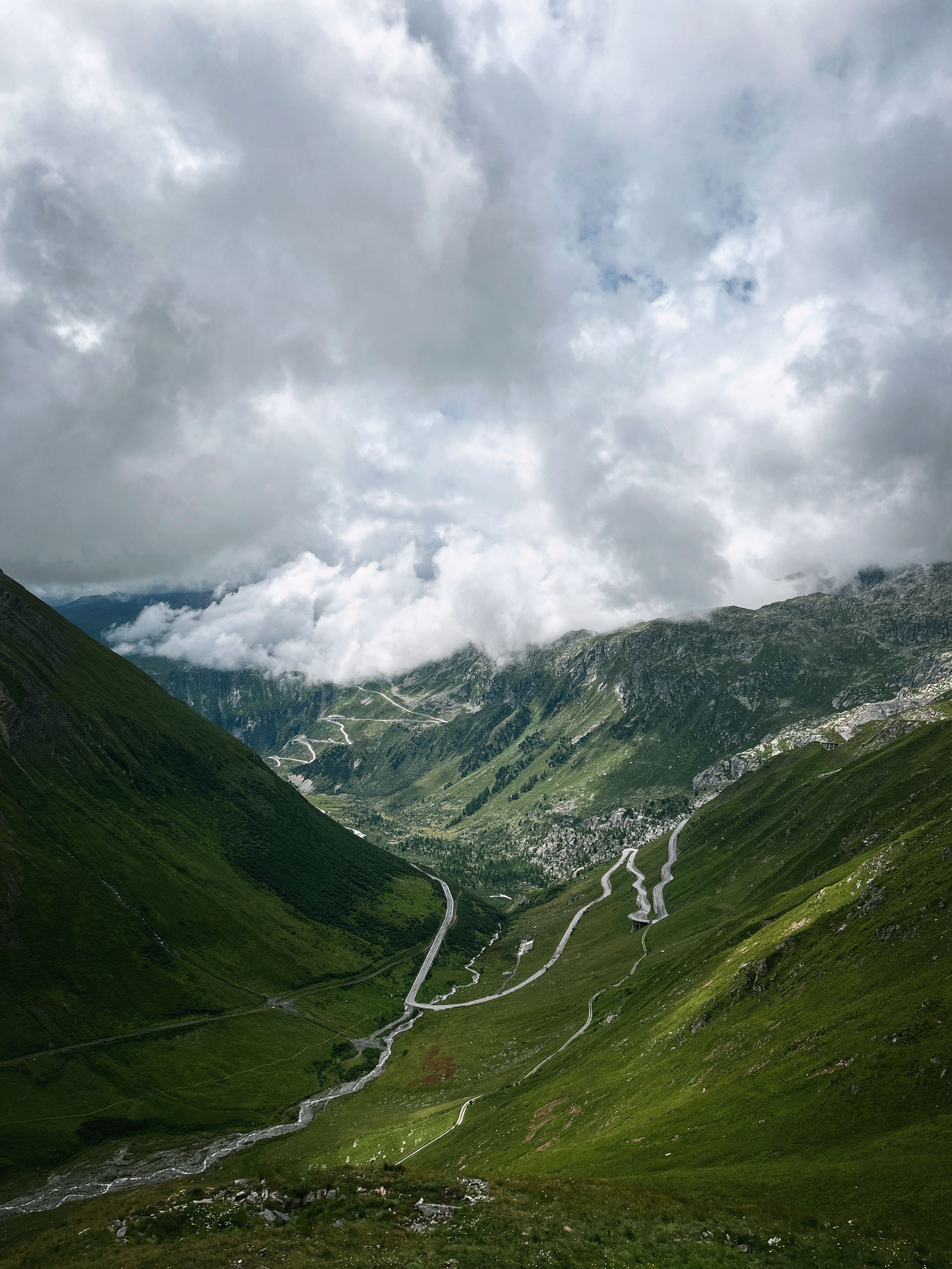 Scenic Alpine Landscape with Winding Mountain Road · Free Stock Photo