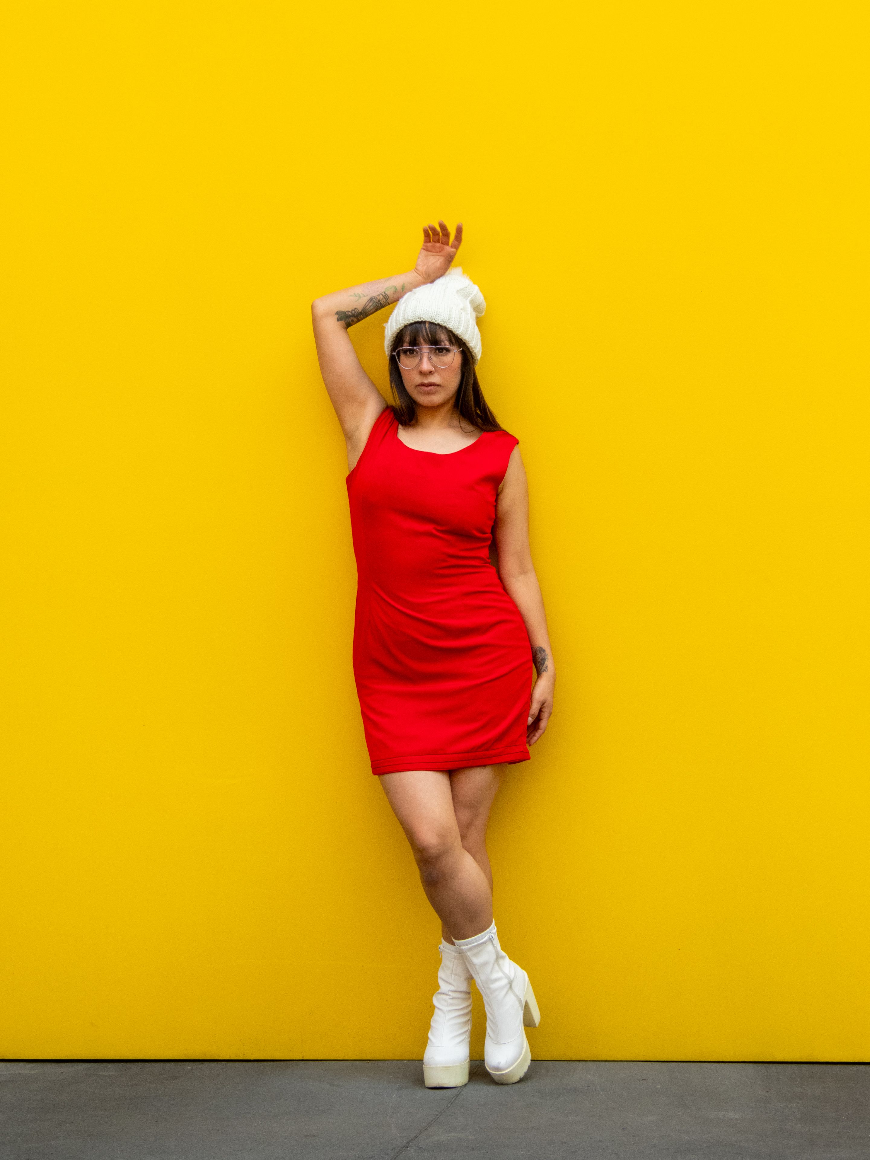 Fashionable Woman in Red Against Yellow Wall · Free Stock Photo