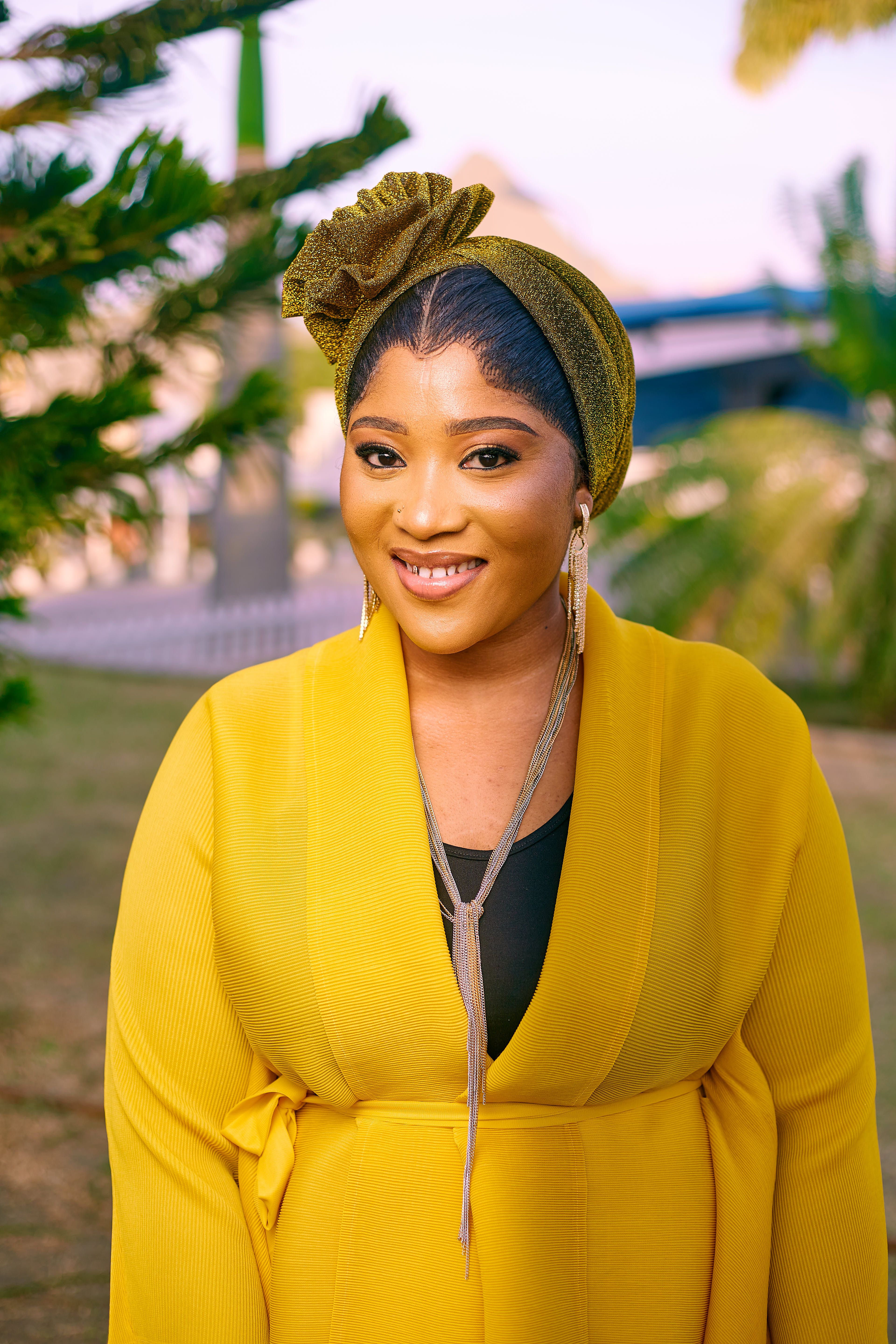Smiling Woman in Bright Yellow Outfit Outdoors · Free Stock Photo