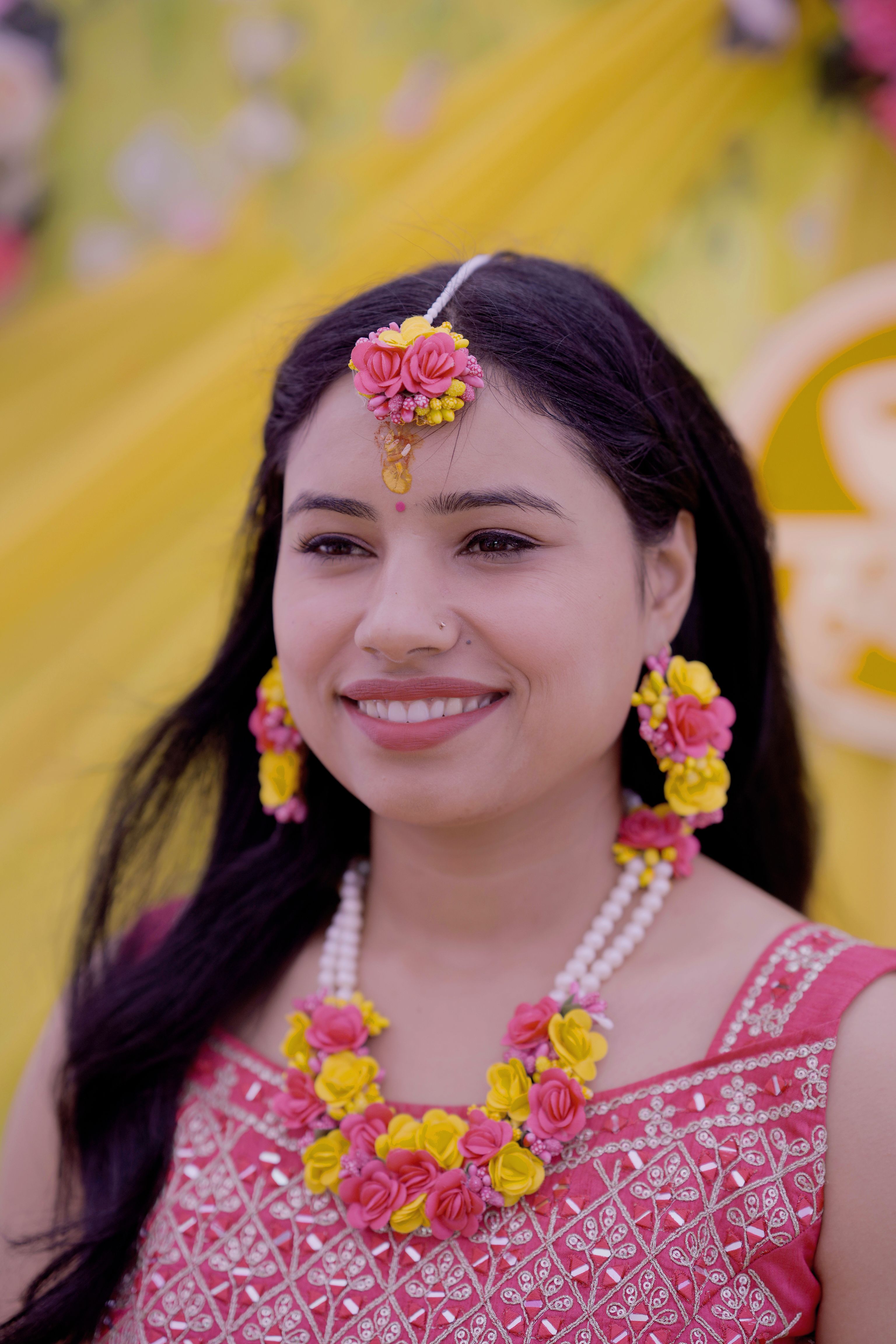 Elegant Woman with Floral Jewelry at Ceremony · Free Stock Photo