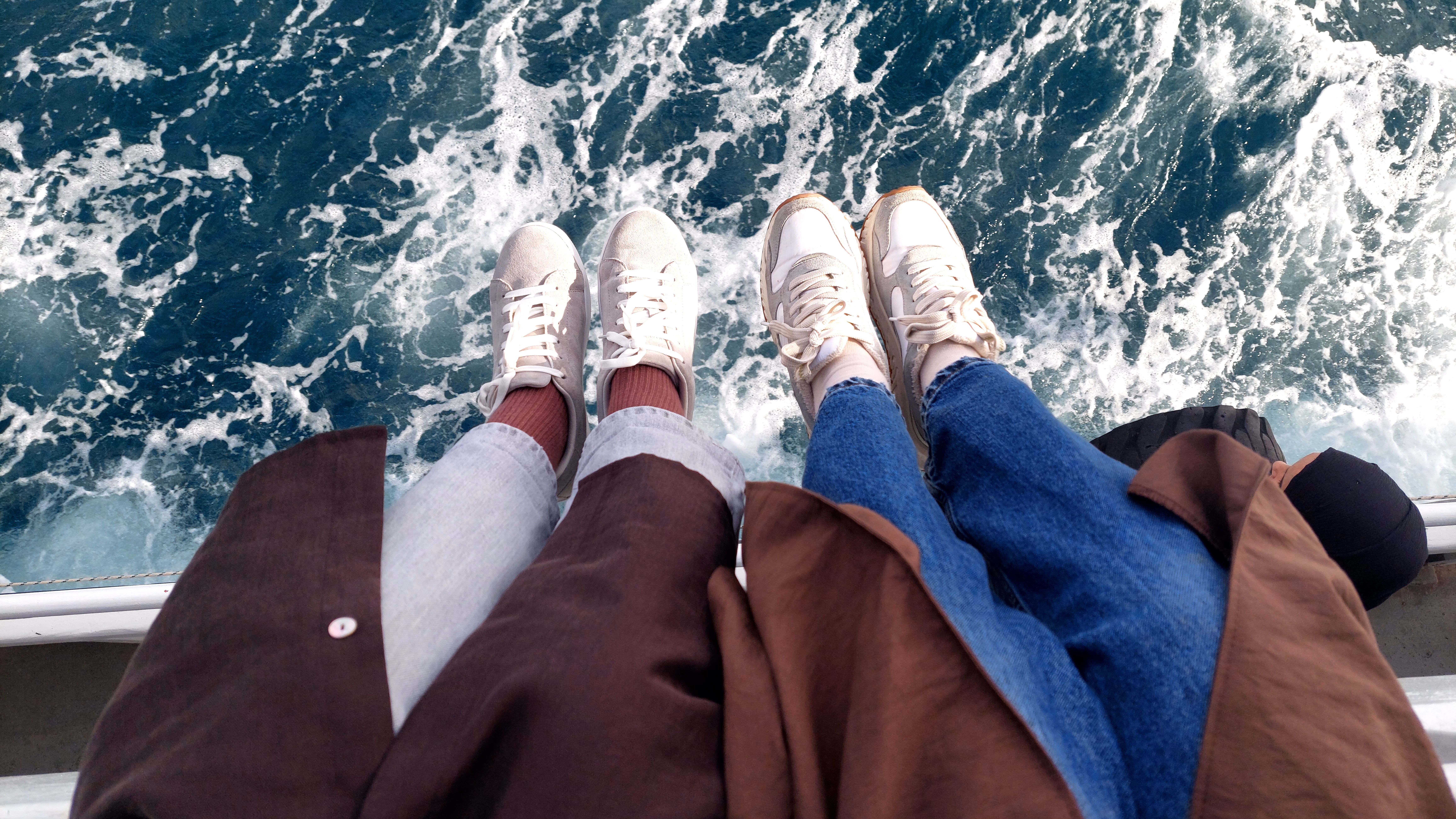 Feet Dangling Over Ocean on a Seaside Adventure · Free Stock Photo