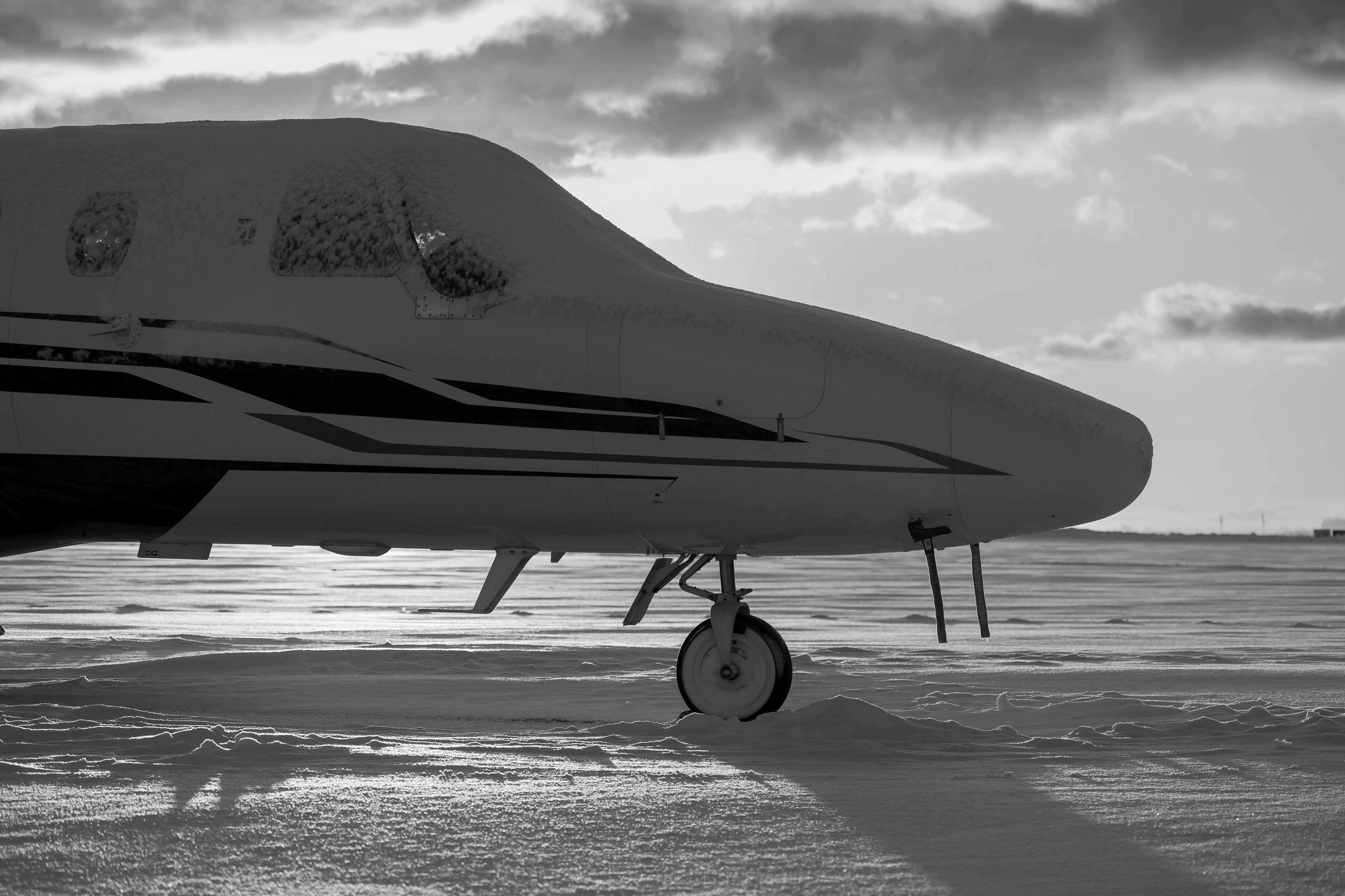 Snow-Covered Airplane on Frozen Tarmac in Winter · Free Stock Photo