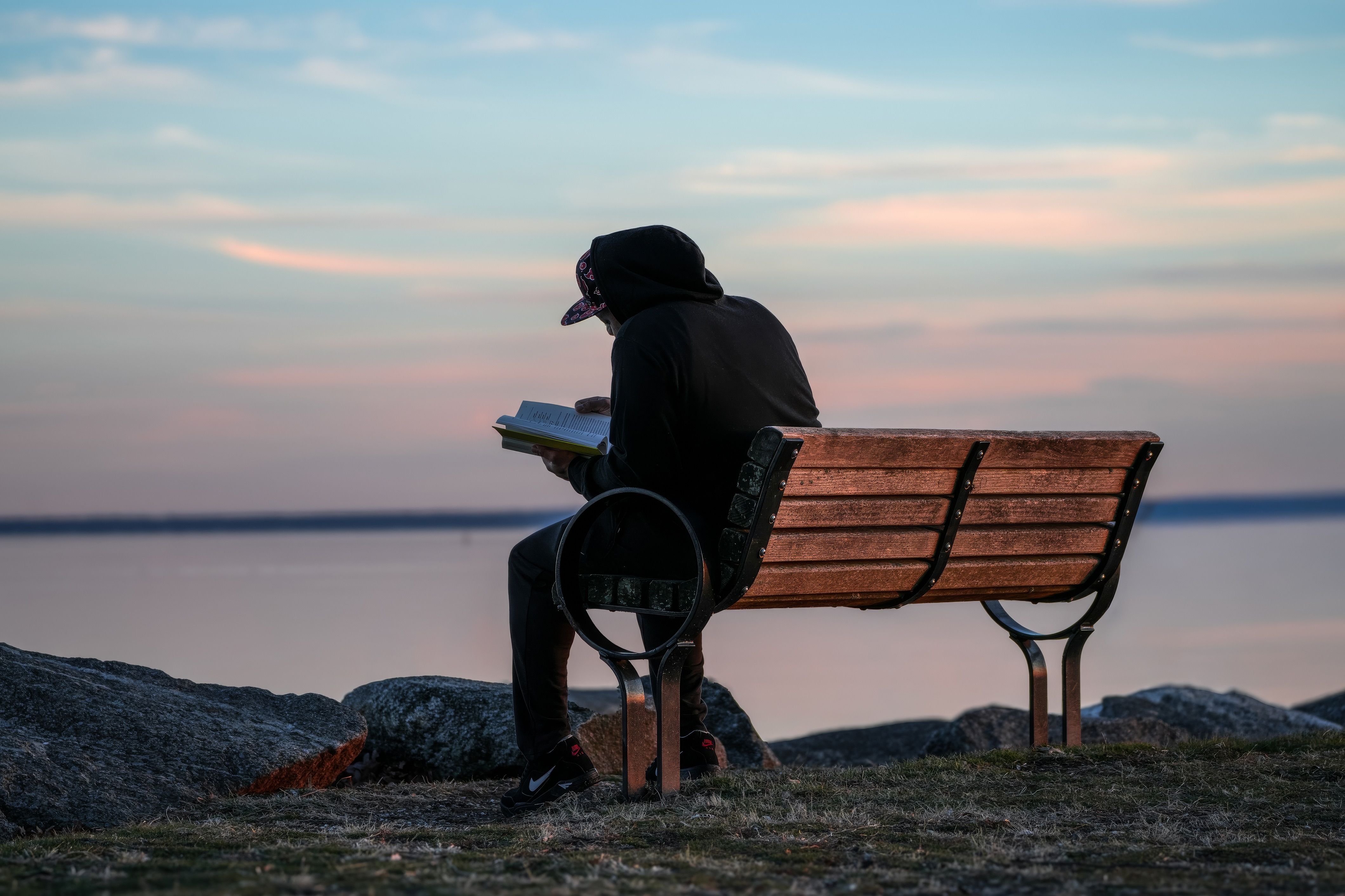 Solitary Reading at Sunset by the Lake · Free Stock Photo