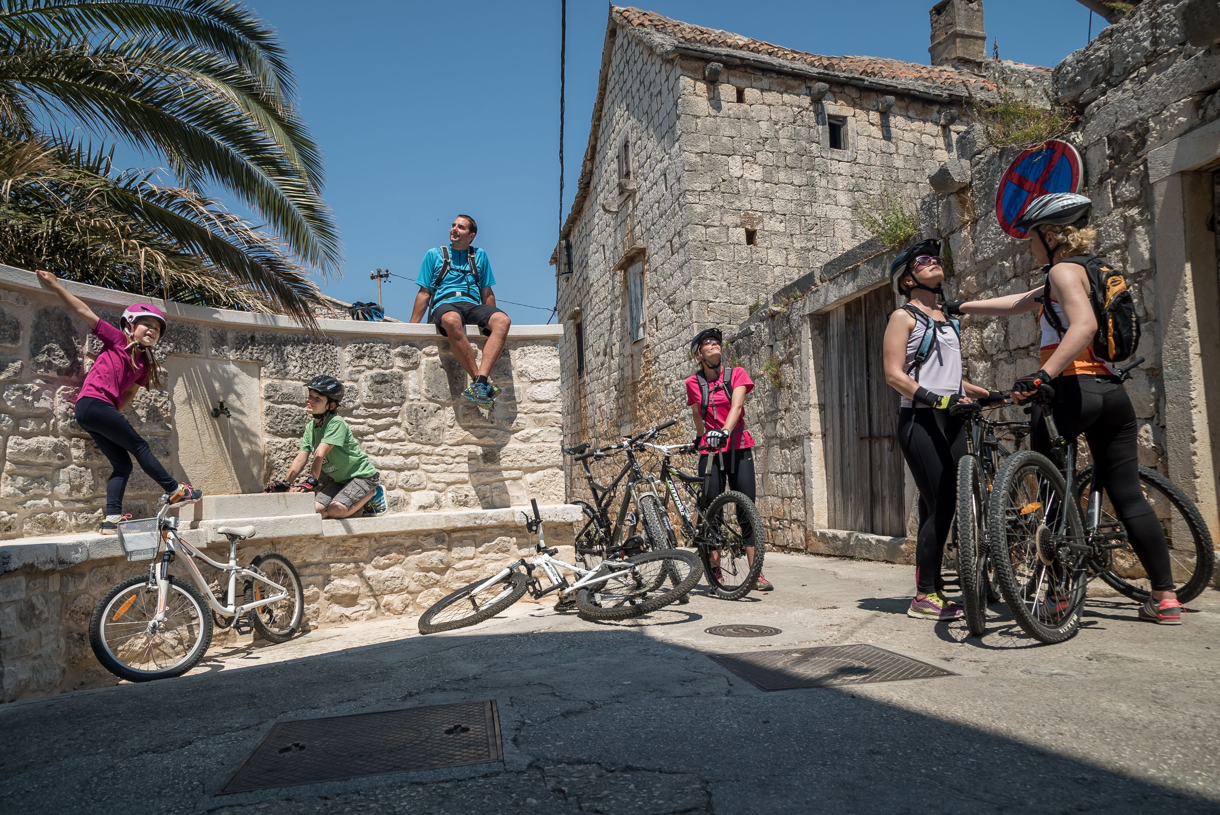 Family Biking Adventure in Historic Village · Free Stock Photo