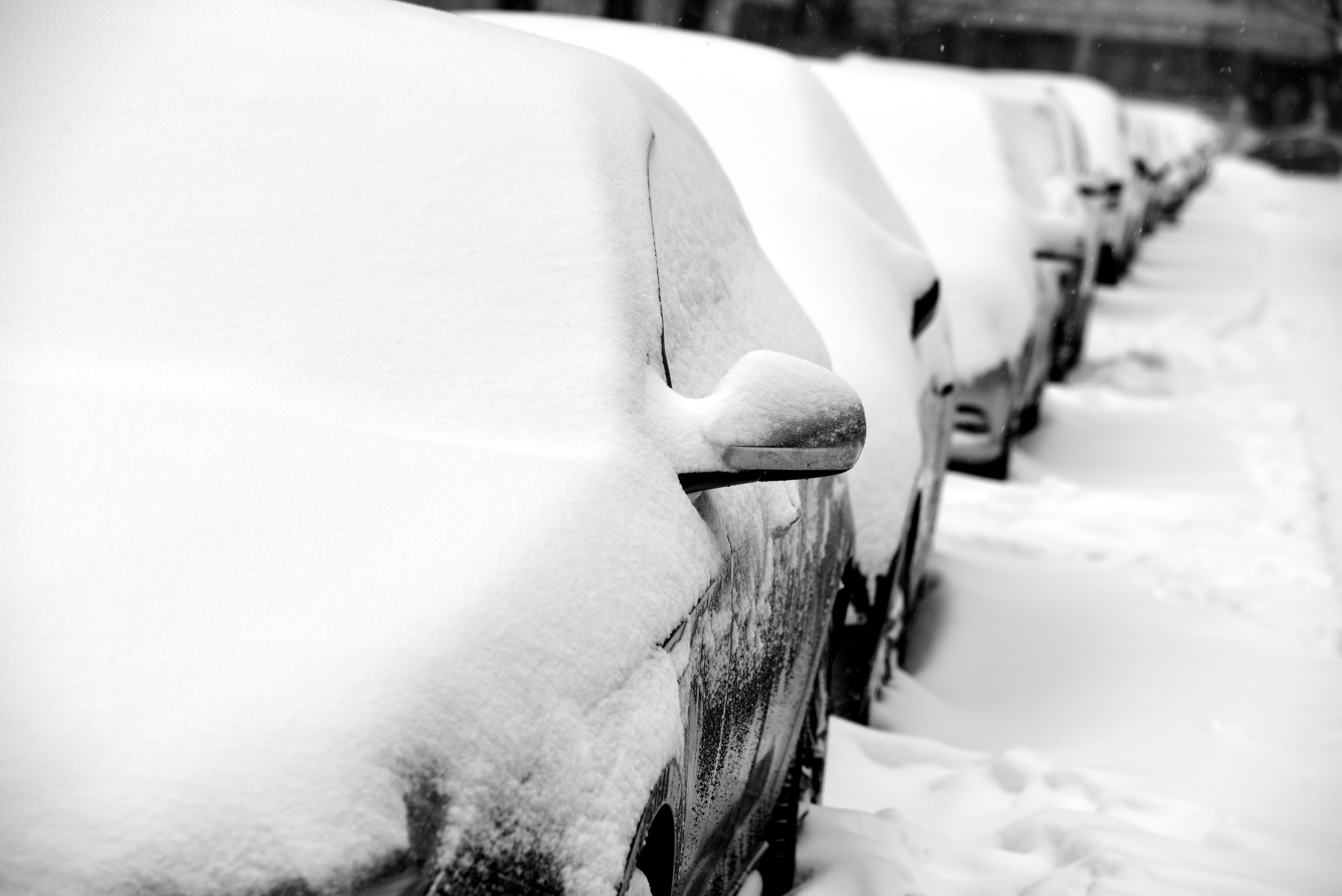 Snow-Covered Cars Lined on Urban Winter Street · Free Stock Photo