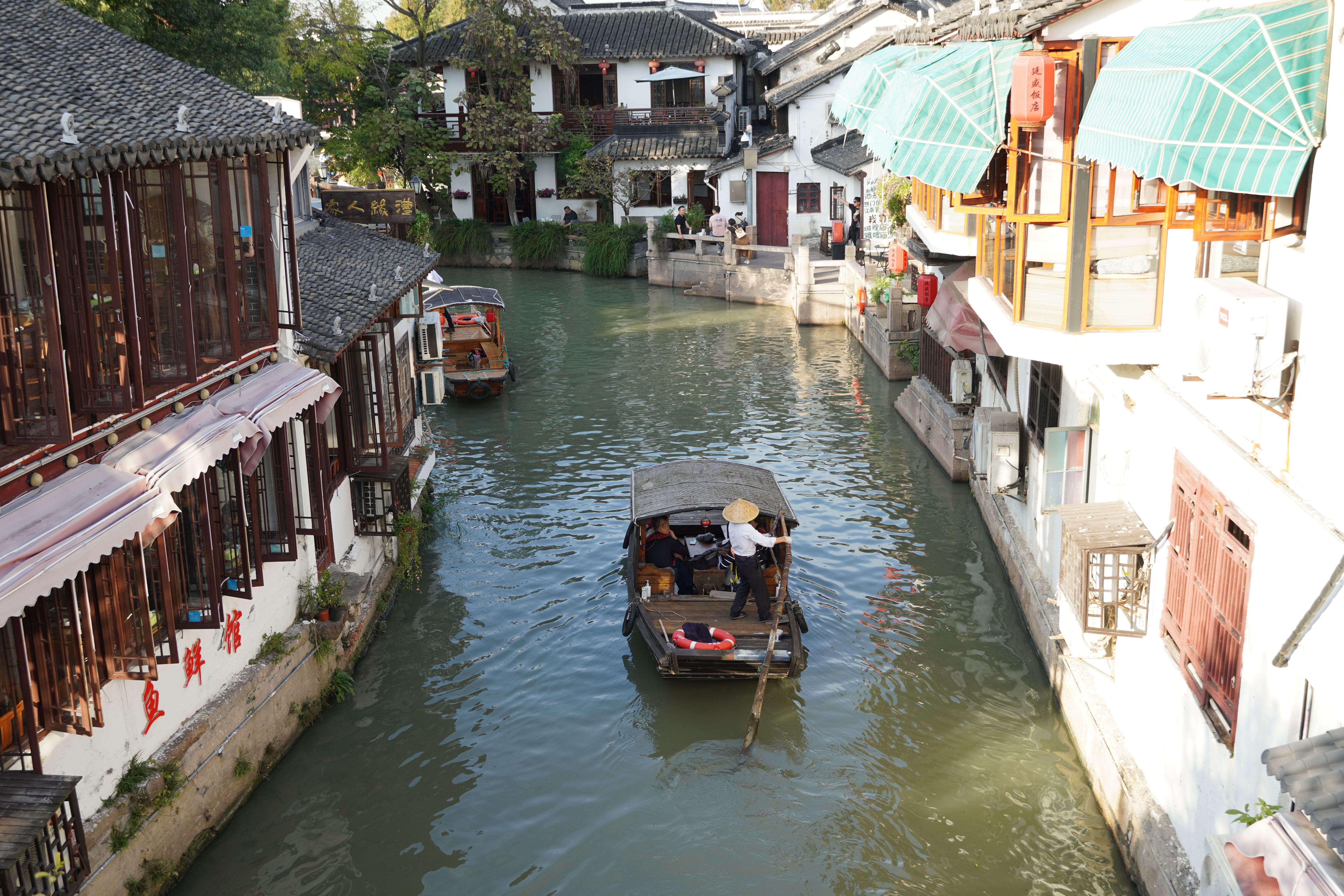 Charming Waterway Scene with Boat in Ancient Town · Free Stock Photo