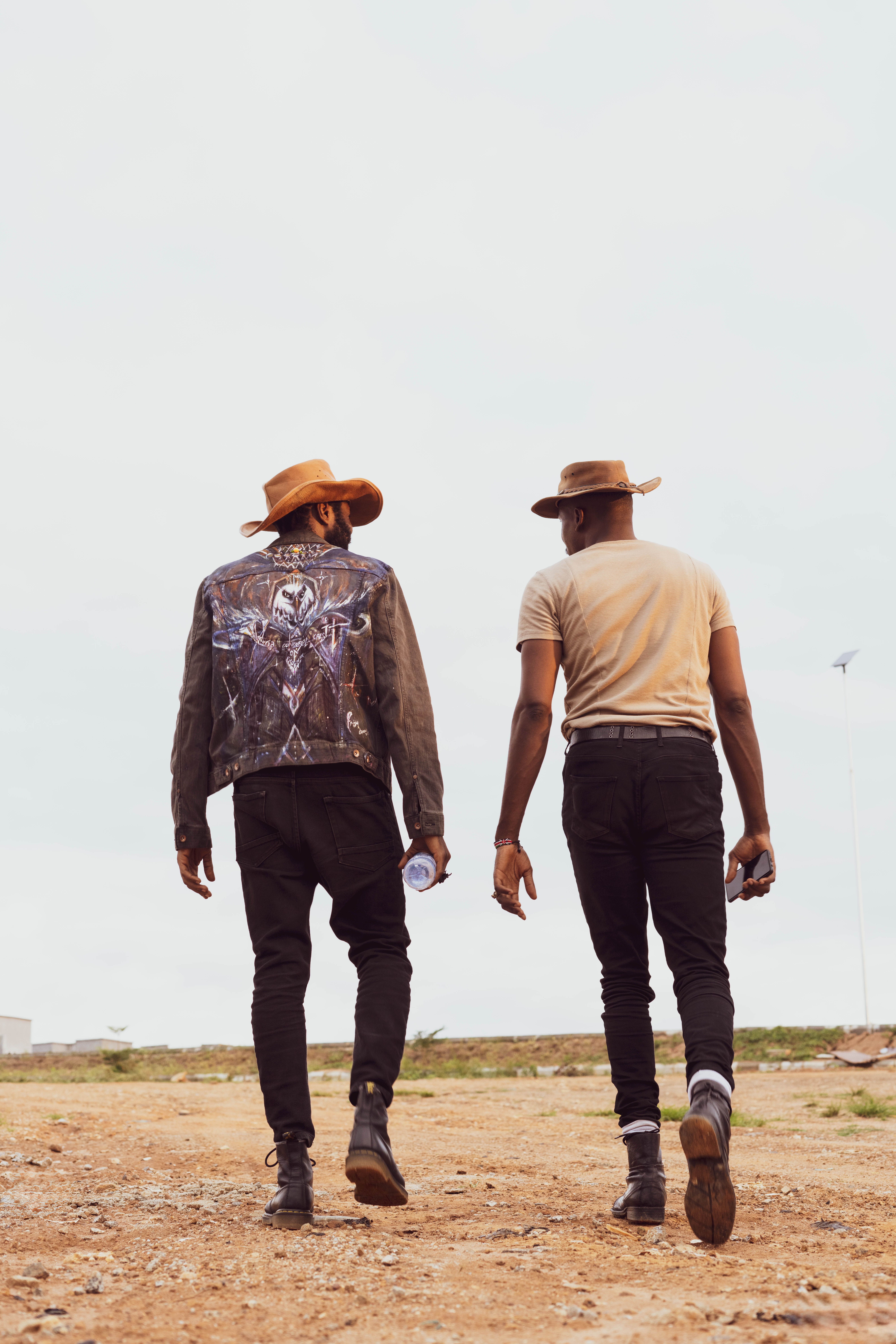Two Stylish Cowboys Walking Outdoors · Free Stock Photo