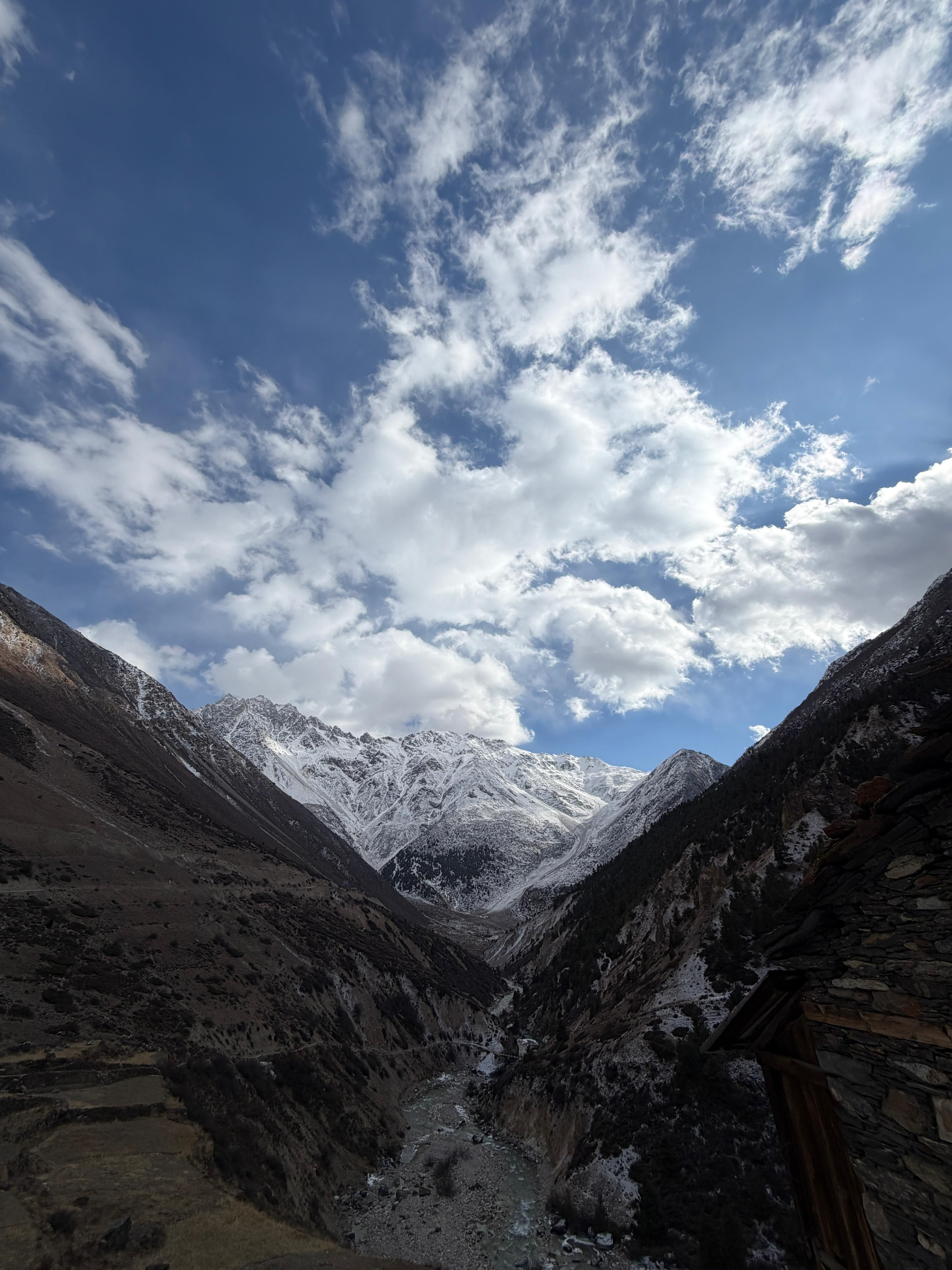 Scenic Mountain Valley with Snow-Capped Peaks and Clouds · Free Stock Photo