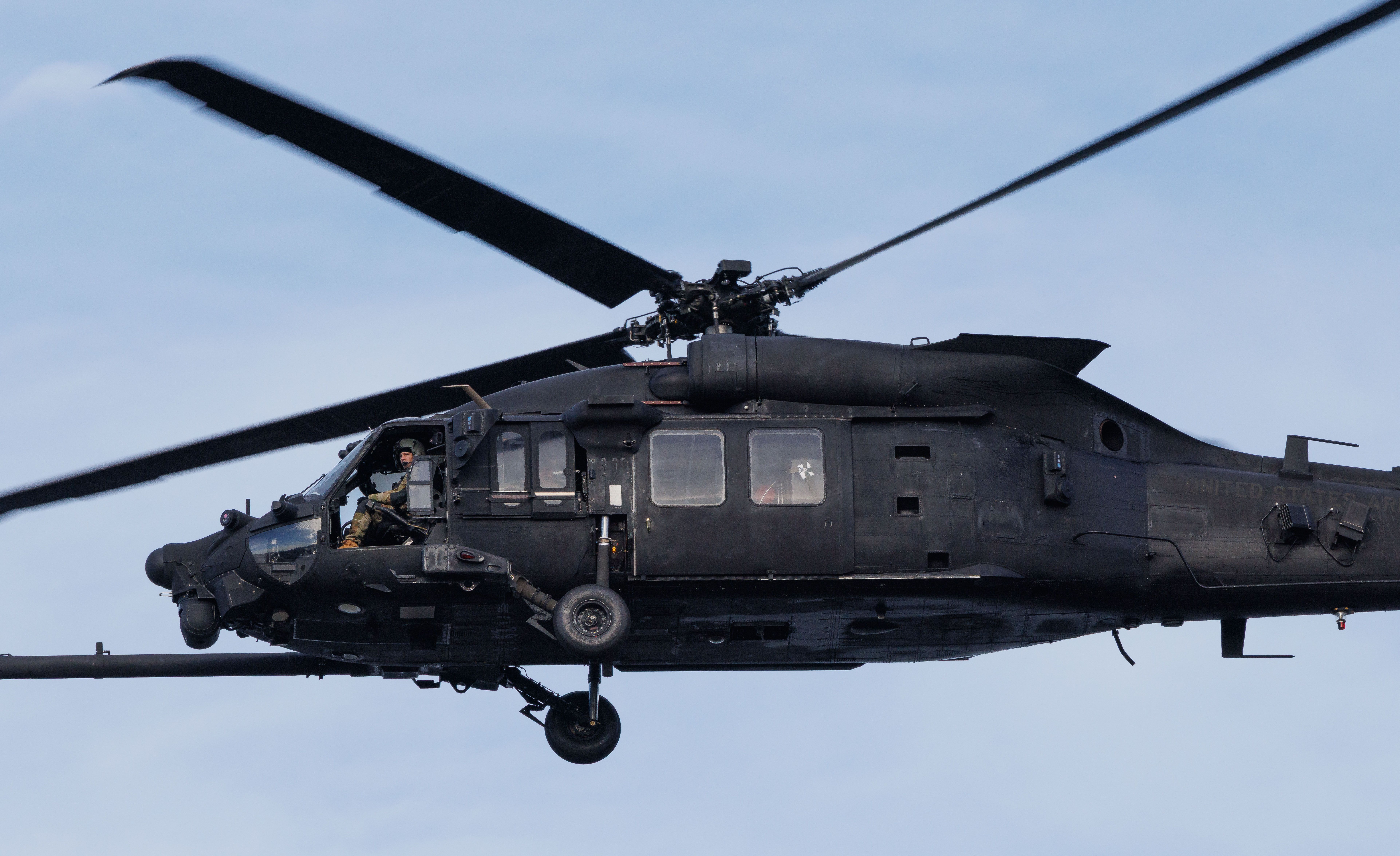 Black Military Helicopter in Flight Against Blue Sky · Free Stock Photo