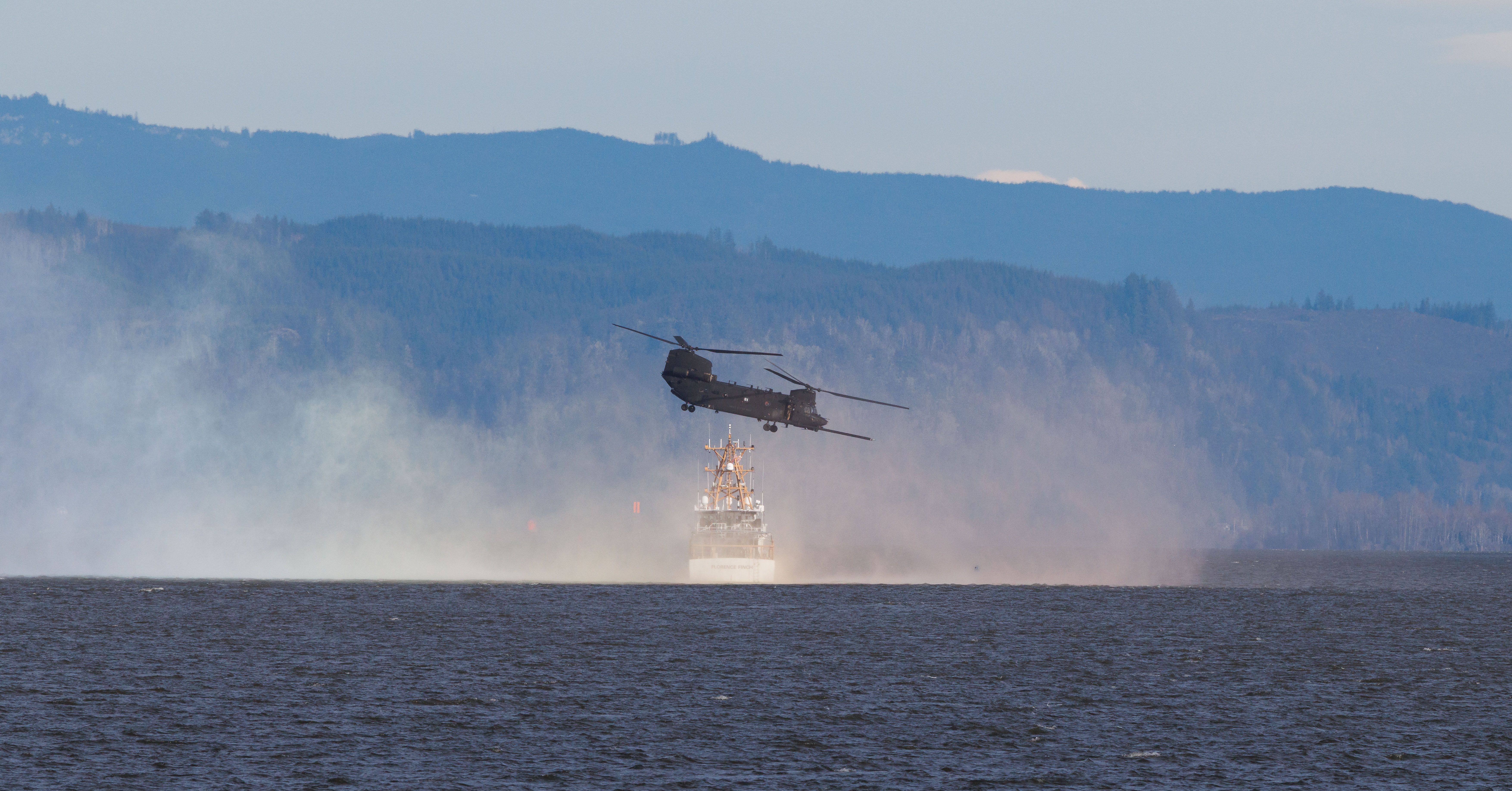 Helicopter Over Water with Mountain Background · Free Stock Photo