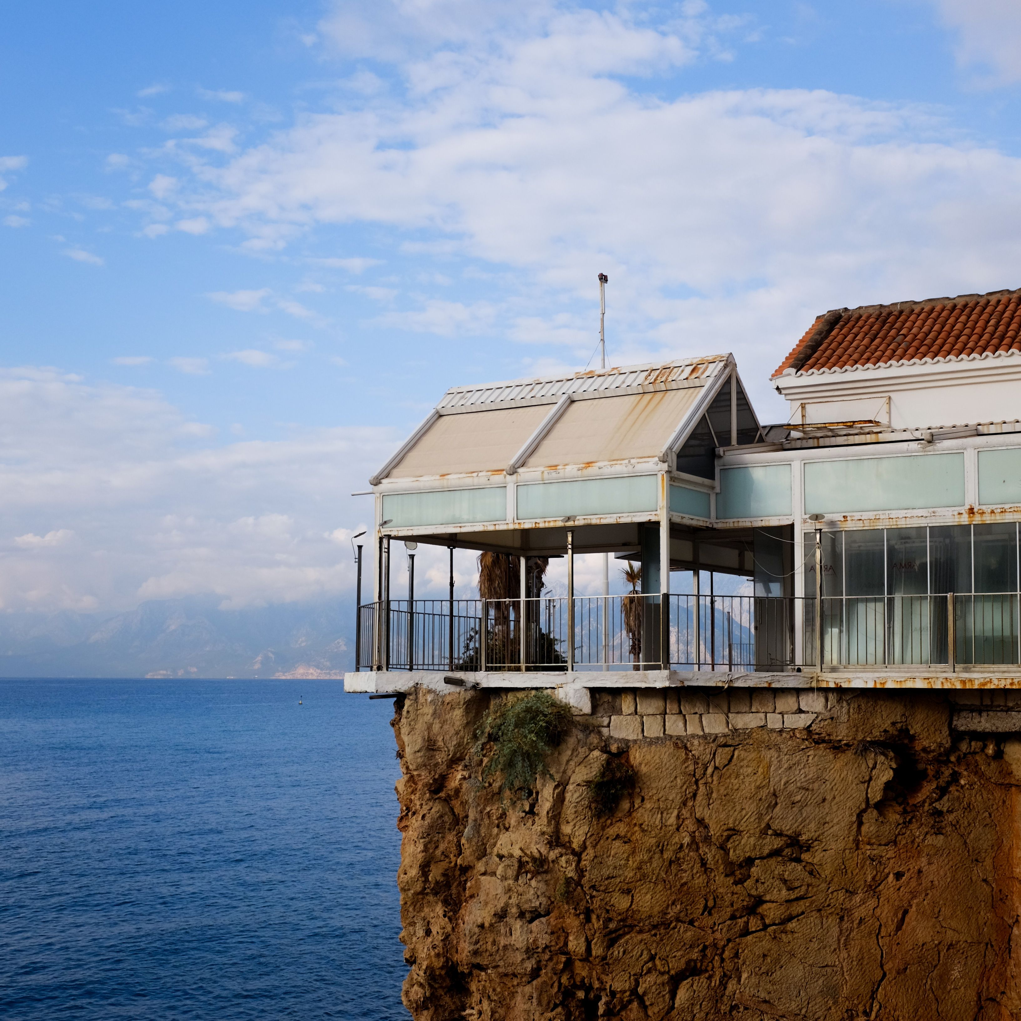 Cliffside House Overlooking Ocean Scenic View · Free Stock Photo