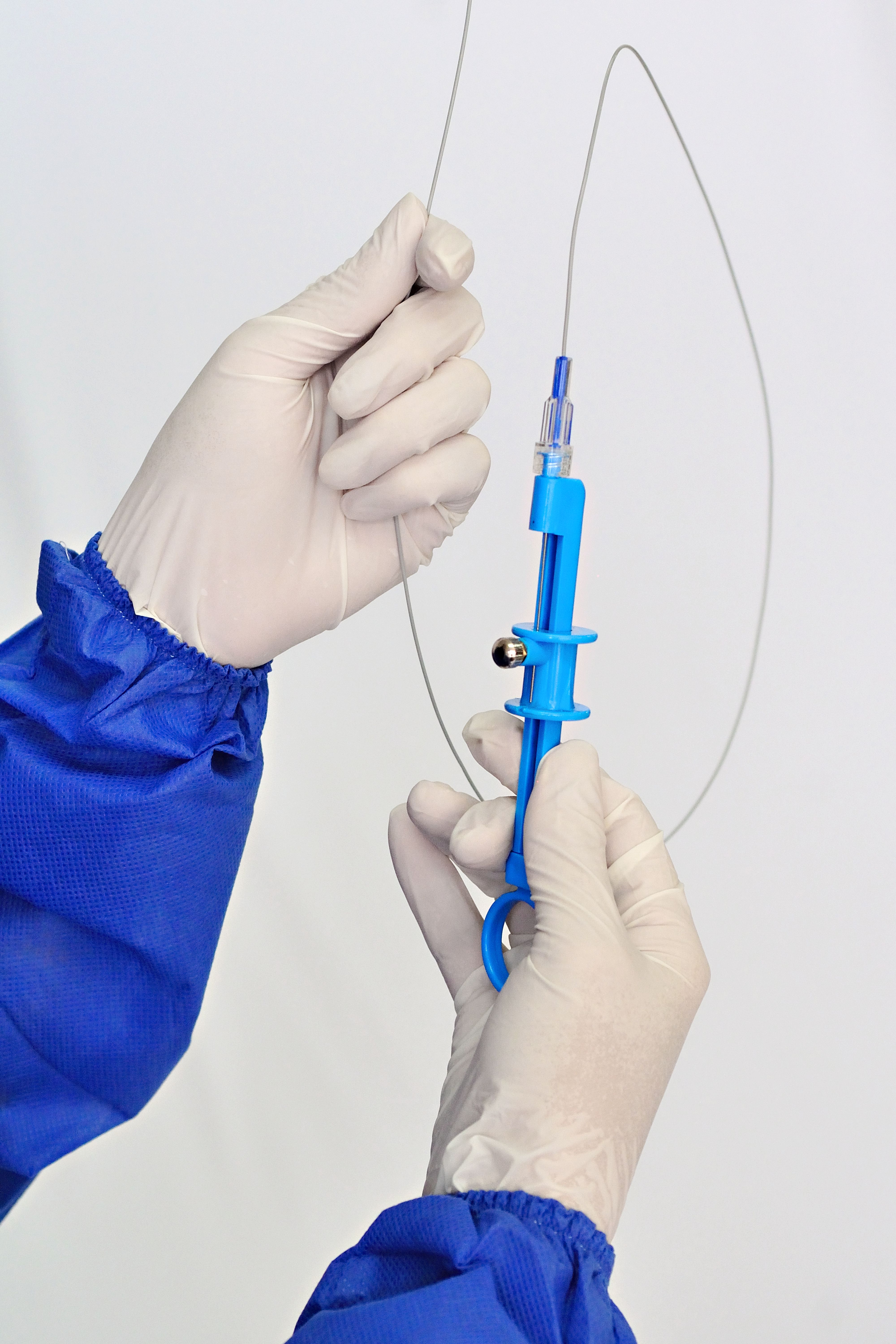 Medical Device Held by Gloved Hands in Surgical Setting · Free Stock Photo