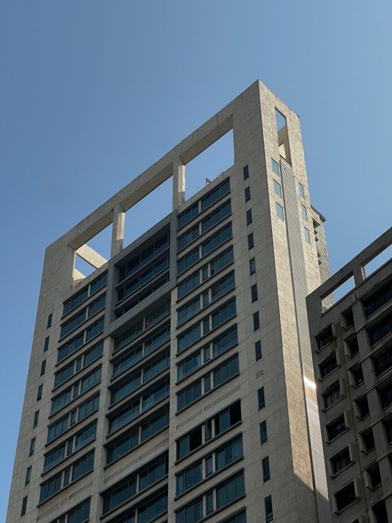 Modern High-Rise Building with Unique Architecture · Free Stock Photo