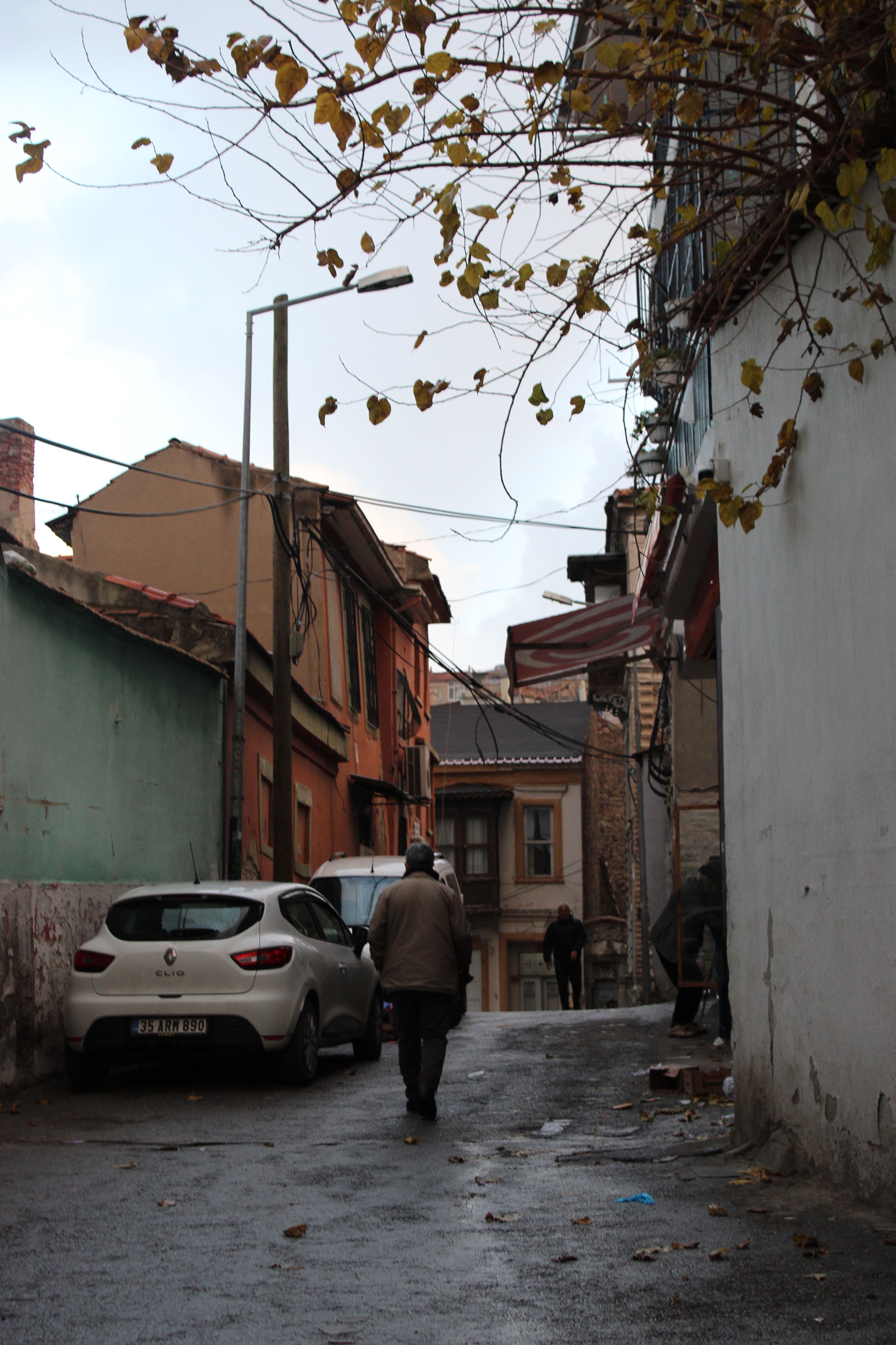 Man Strolling in Narrow Urban Alleyway · Free Stock Photo