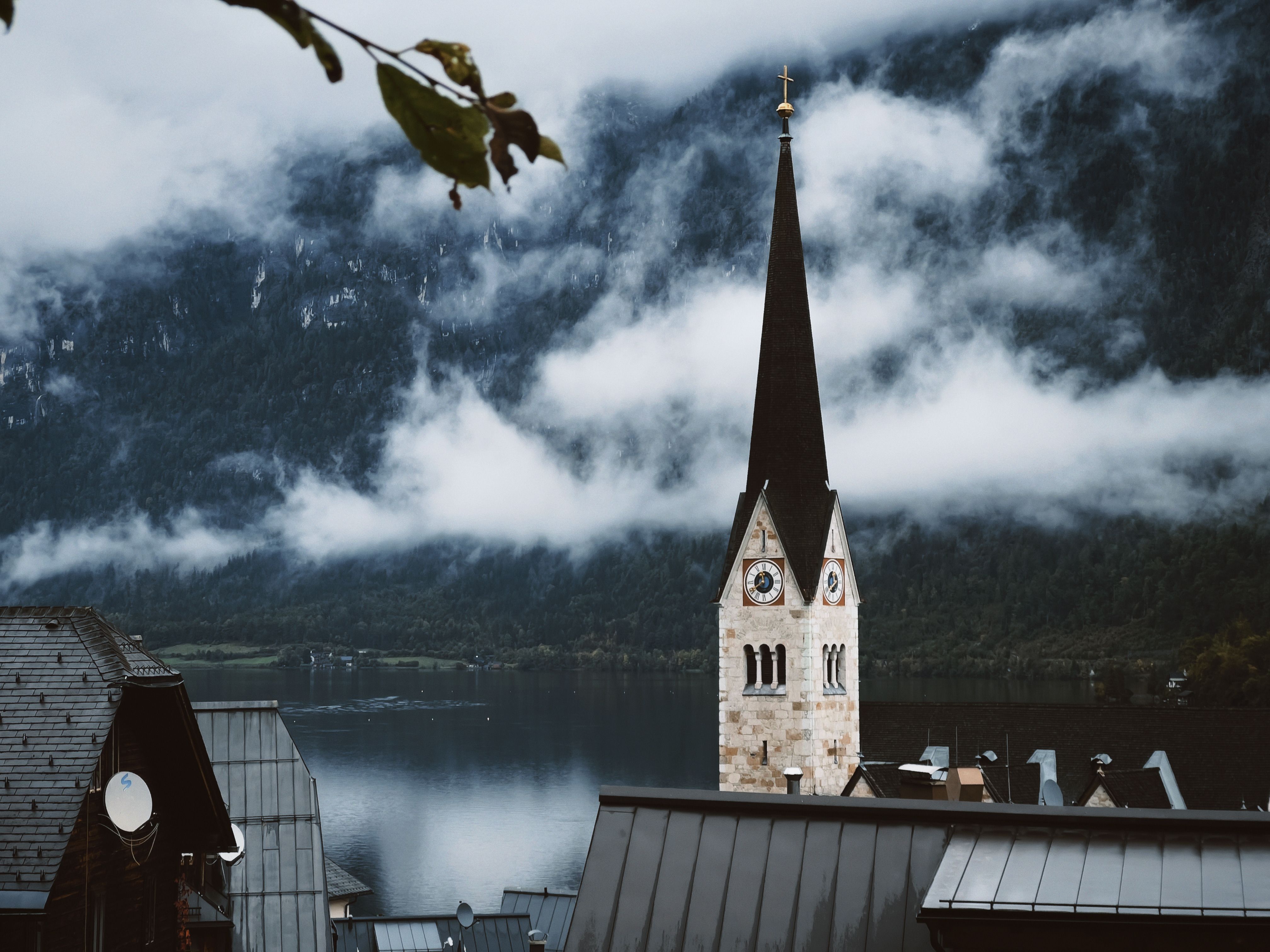 Gothic Church Tower in Misty Alpine Village · Free Stock Photo