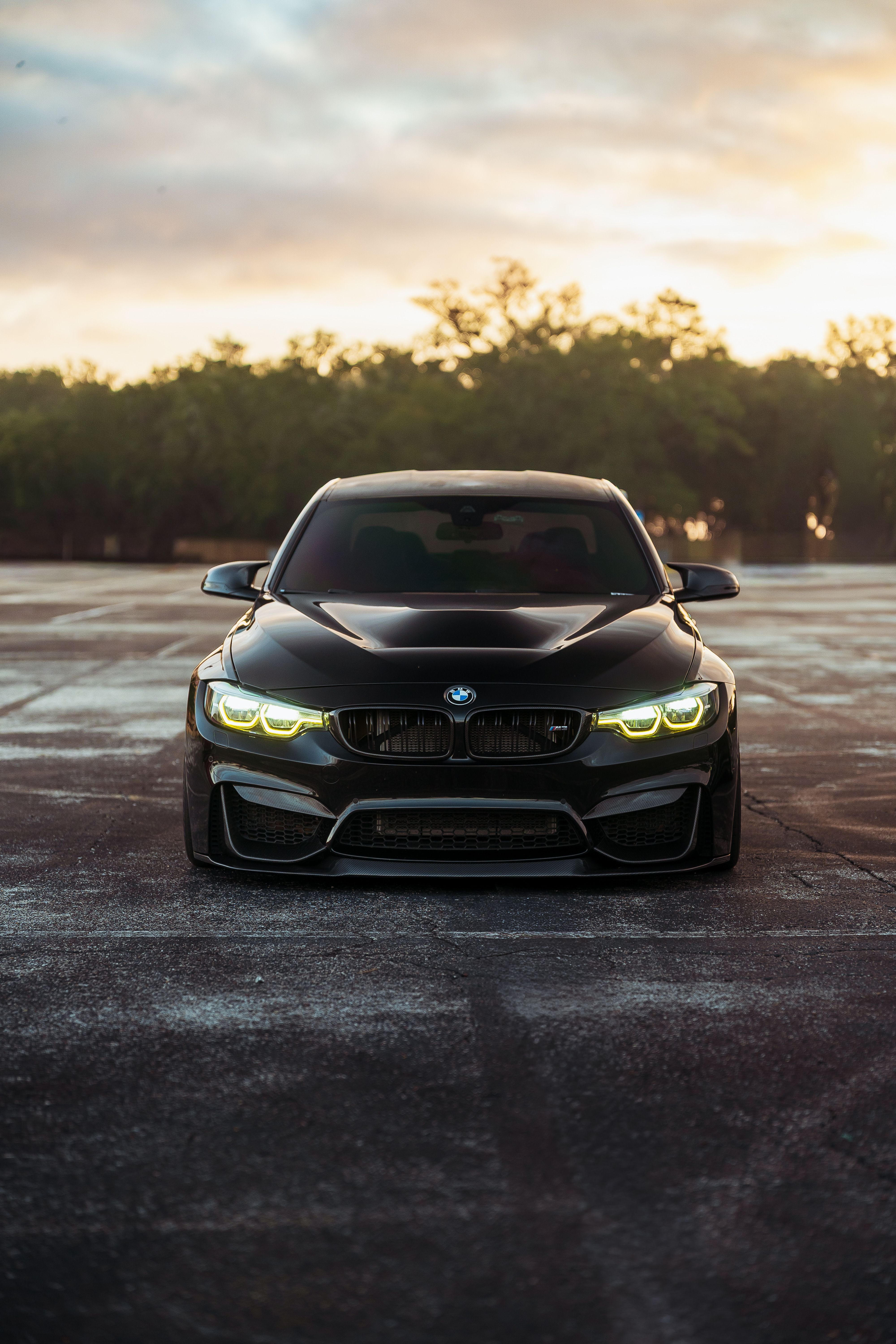 Sleek black car on empty road at sunset · Free Stock Photo