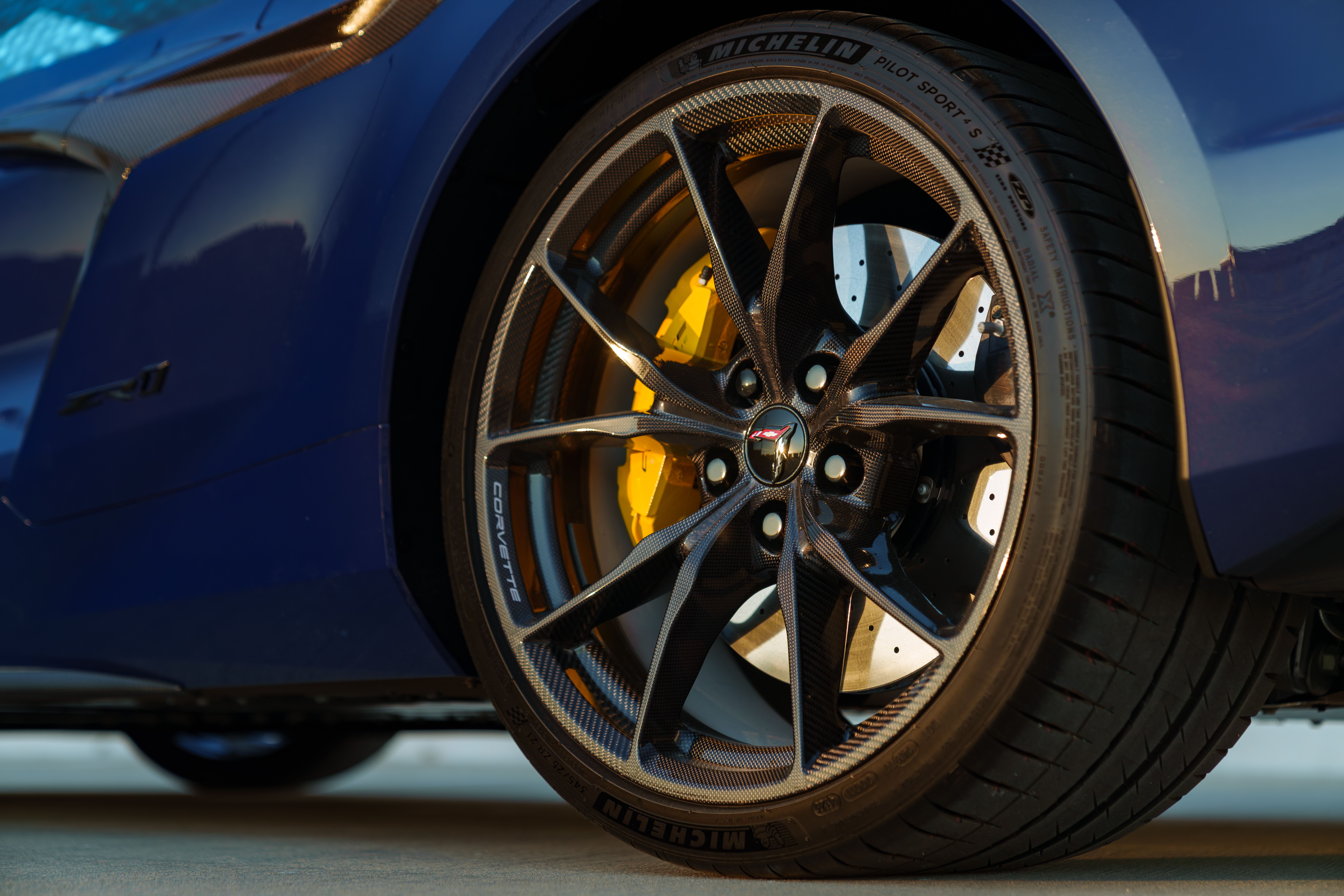 Close-up of a Luxury Car Wheel with Yellow Brake Caliper · Free Stock Photo
