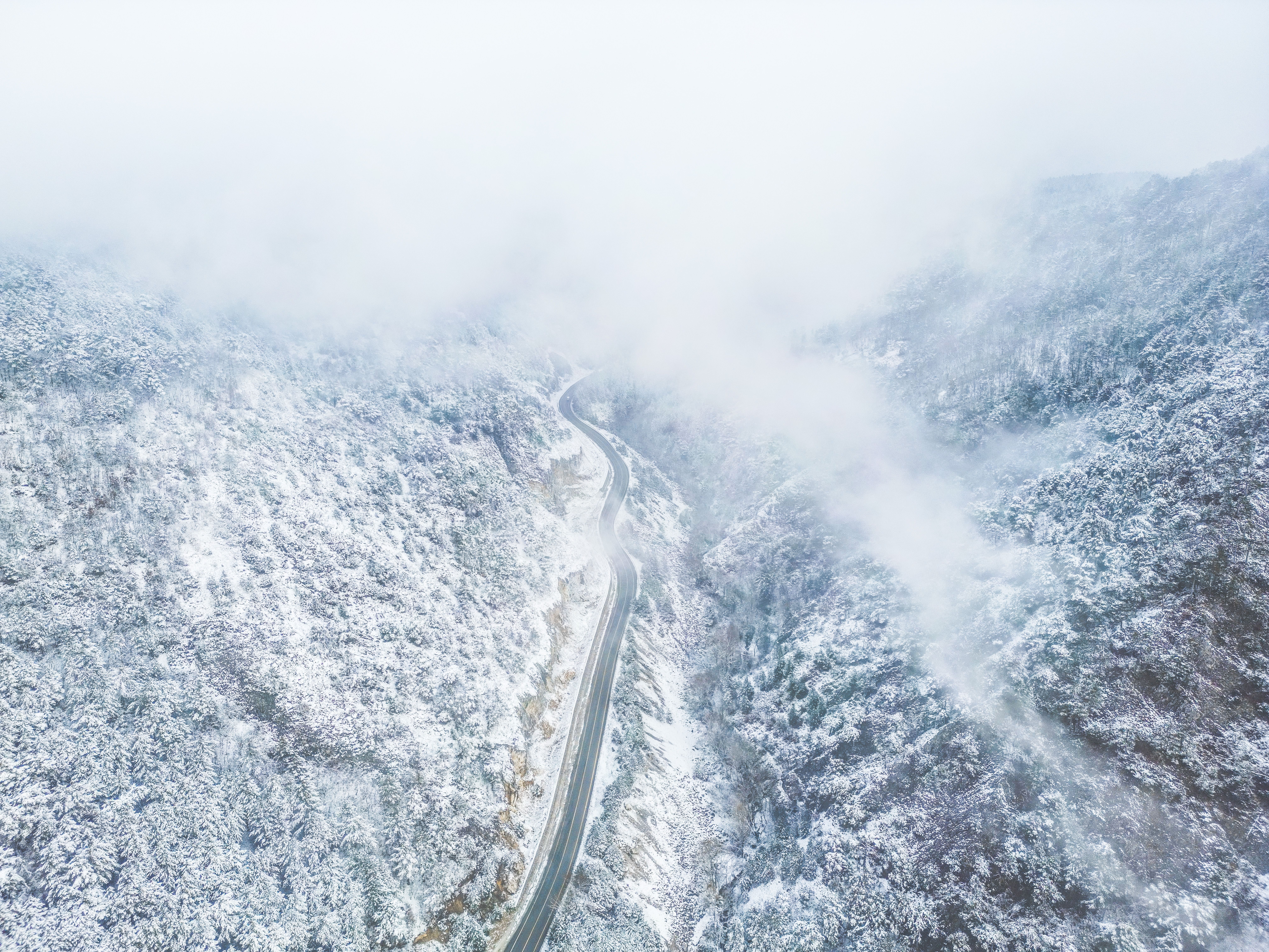 Aerial View of Snowy Mountain Road in Winter · Free Stock Photo
