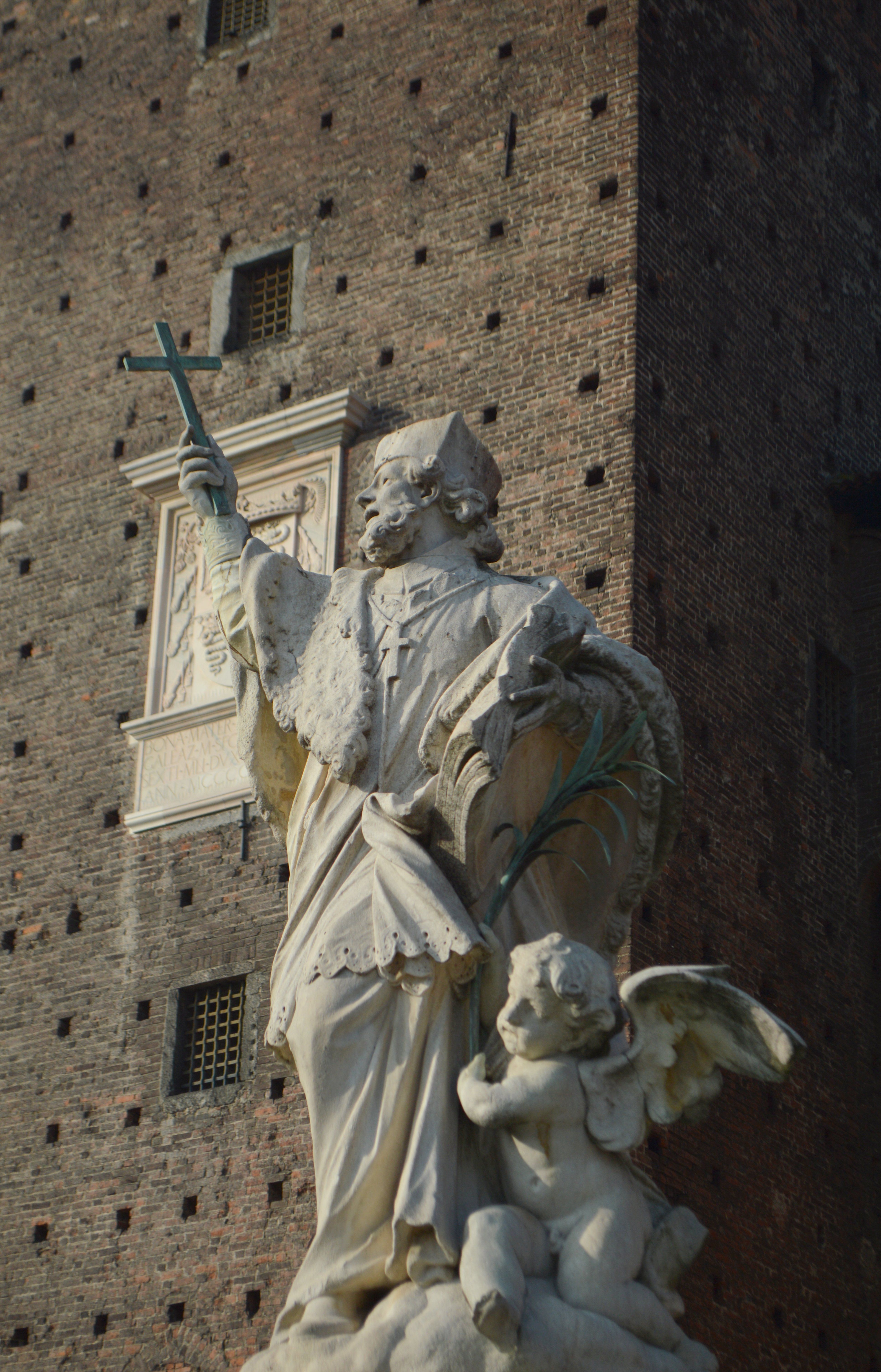 Stone Statue of Bishop with Angel at Historic Building · Free Stock Photo