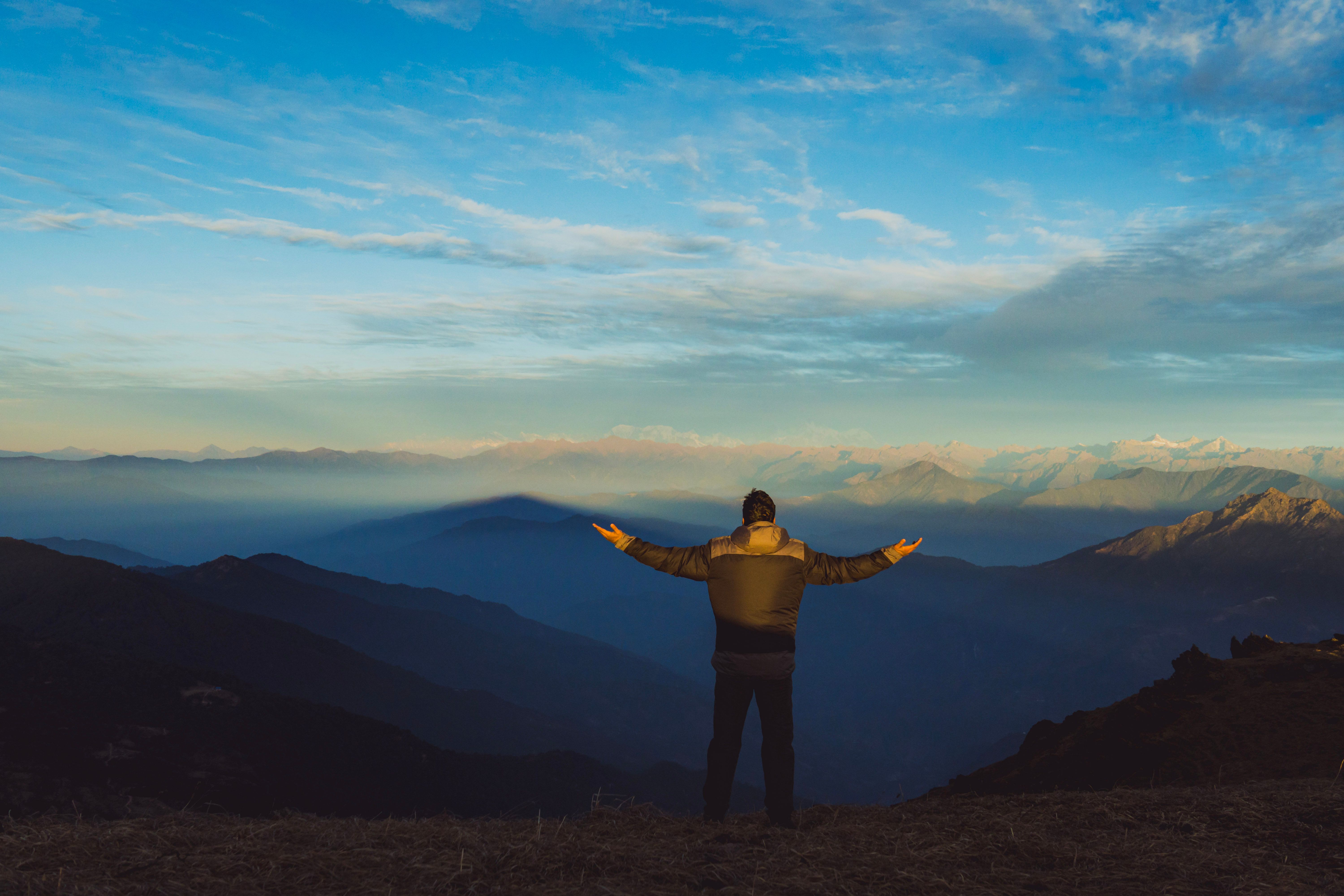 Man Embracing Mountain View at Sunrise · Free Stock Photo