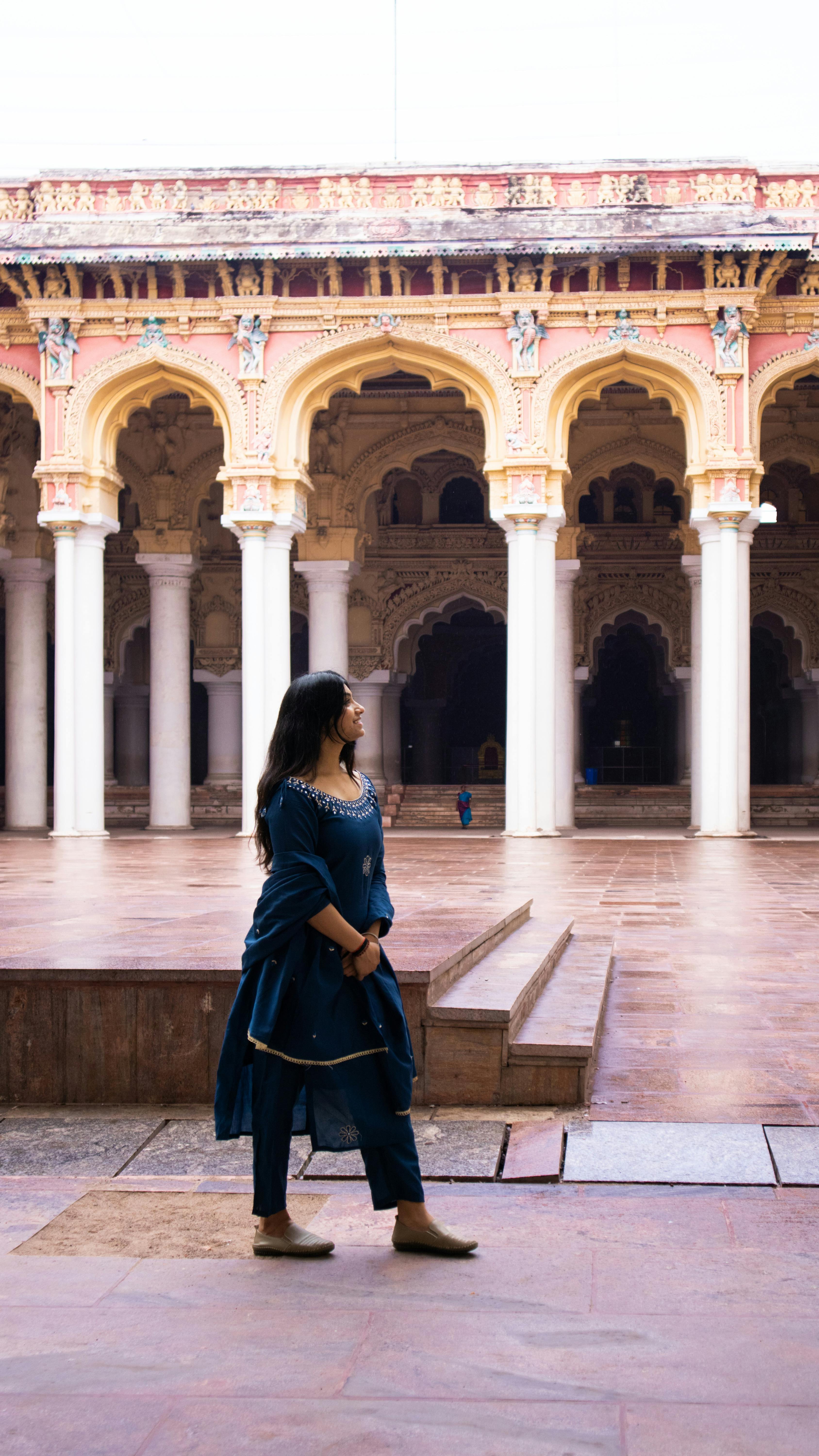 Woman in Traditional Dress at Historic Palace · Free Stock Photo