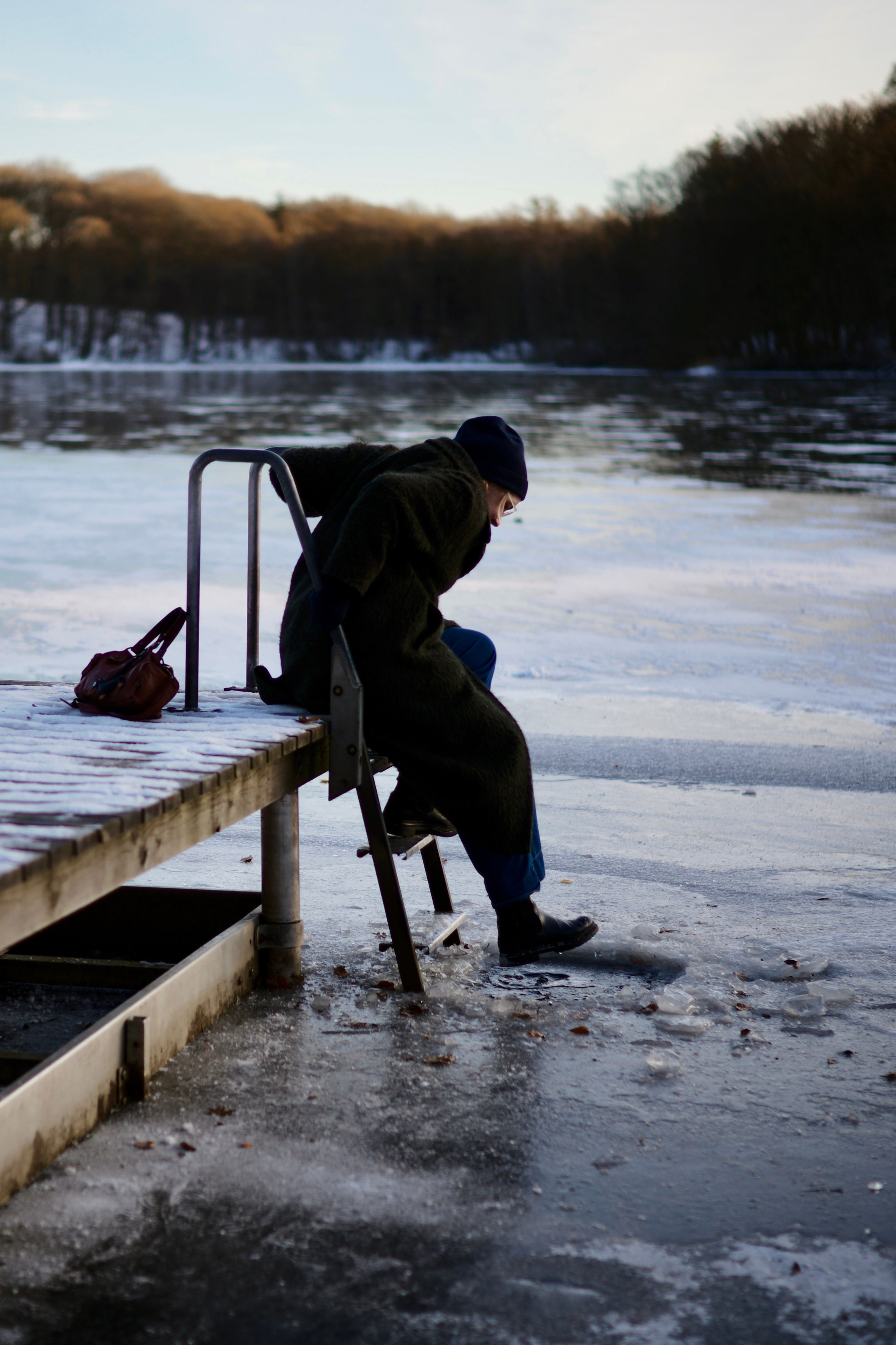 Man on Pier by Frozen Lake in Winter · Free Stock Photo