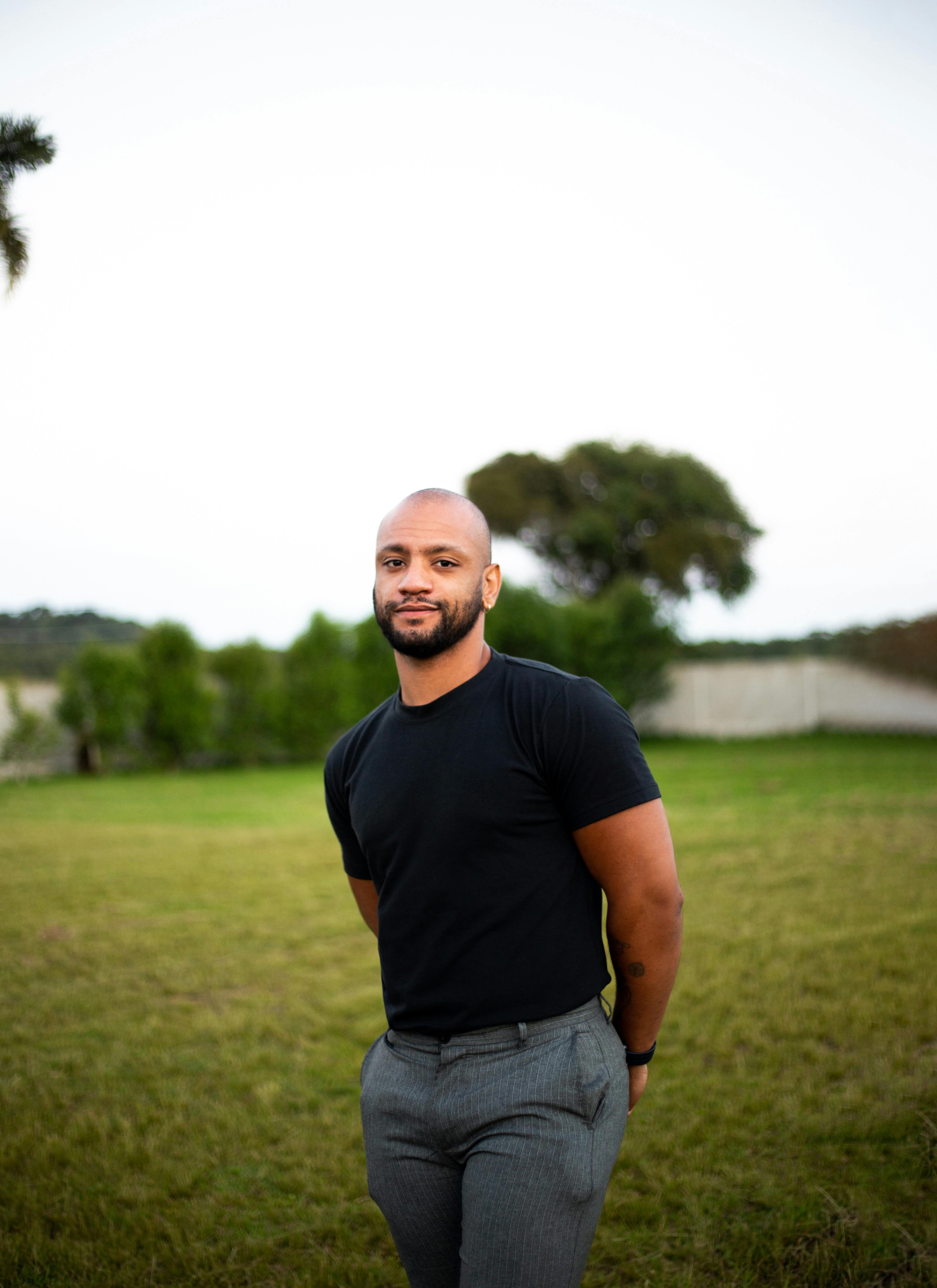 Man Enjoying Nature in Open Field at Dusk · Free Stock Photo