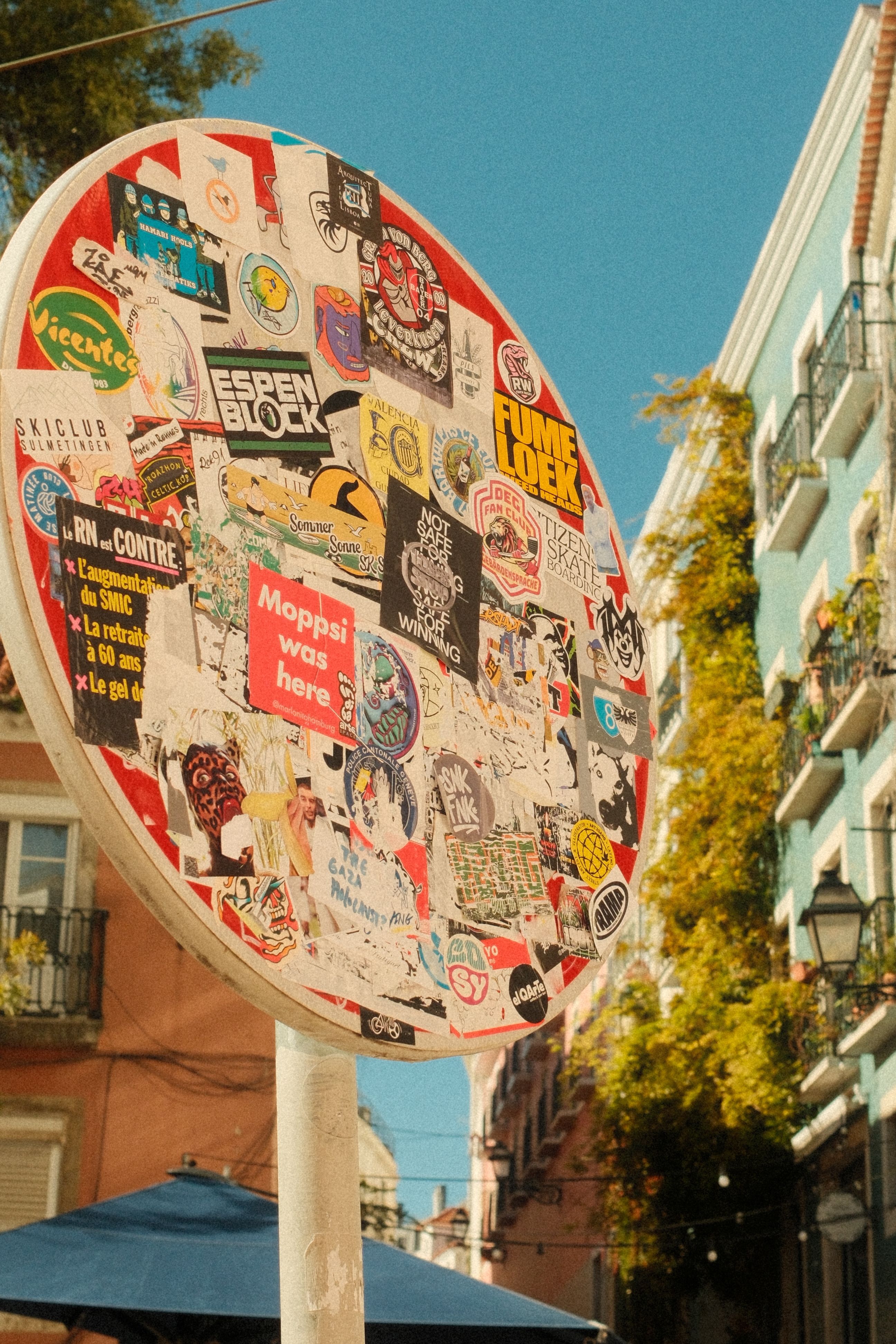 Vibrant Urban Sign with Street Art Stickers · Free Stock Photo