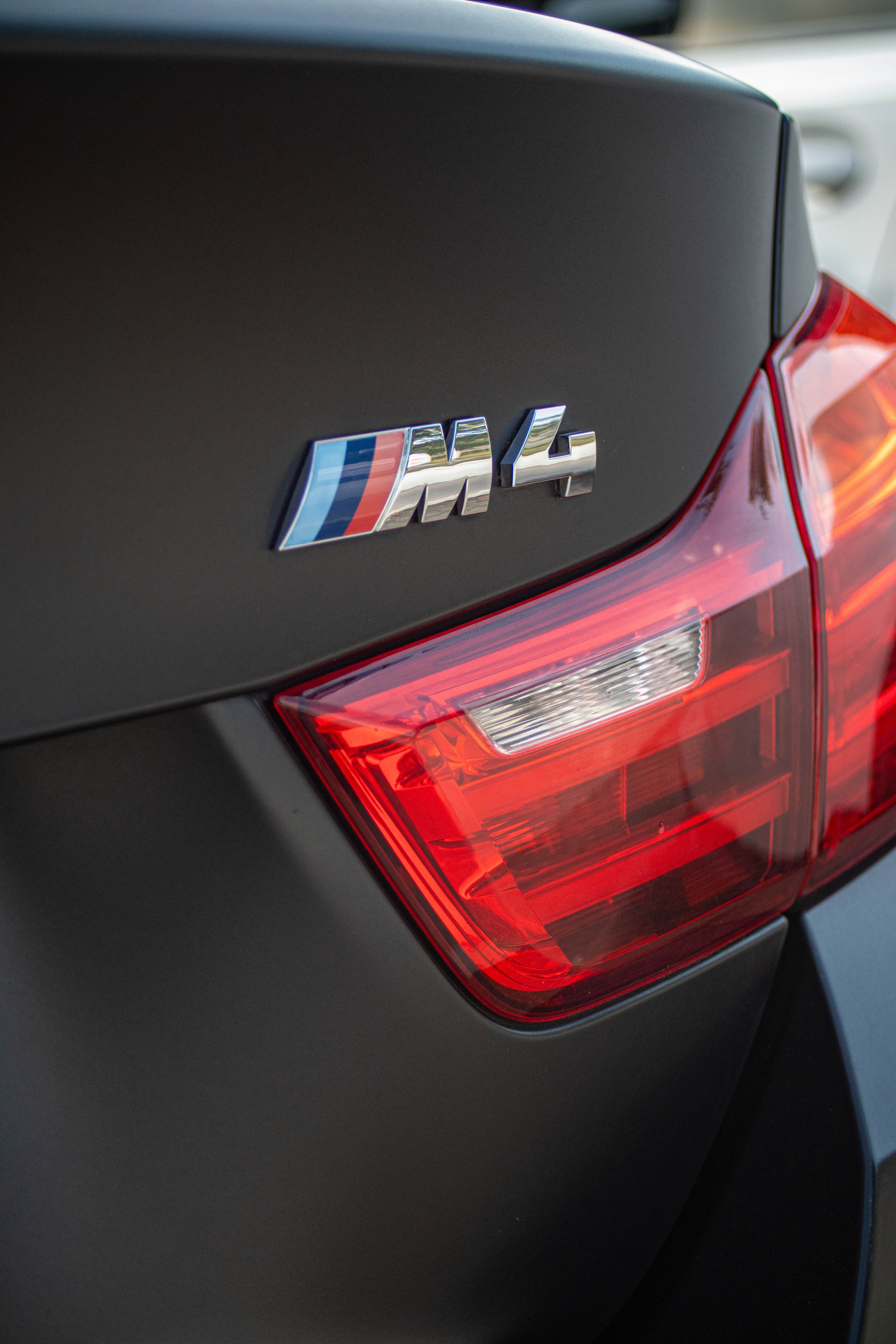 Close-up of Luxury Car Tail Light with Emblem · Free Stock Photo