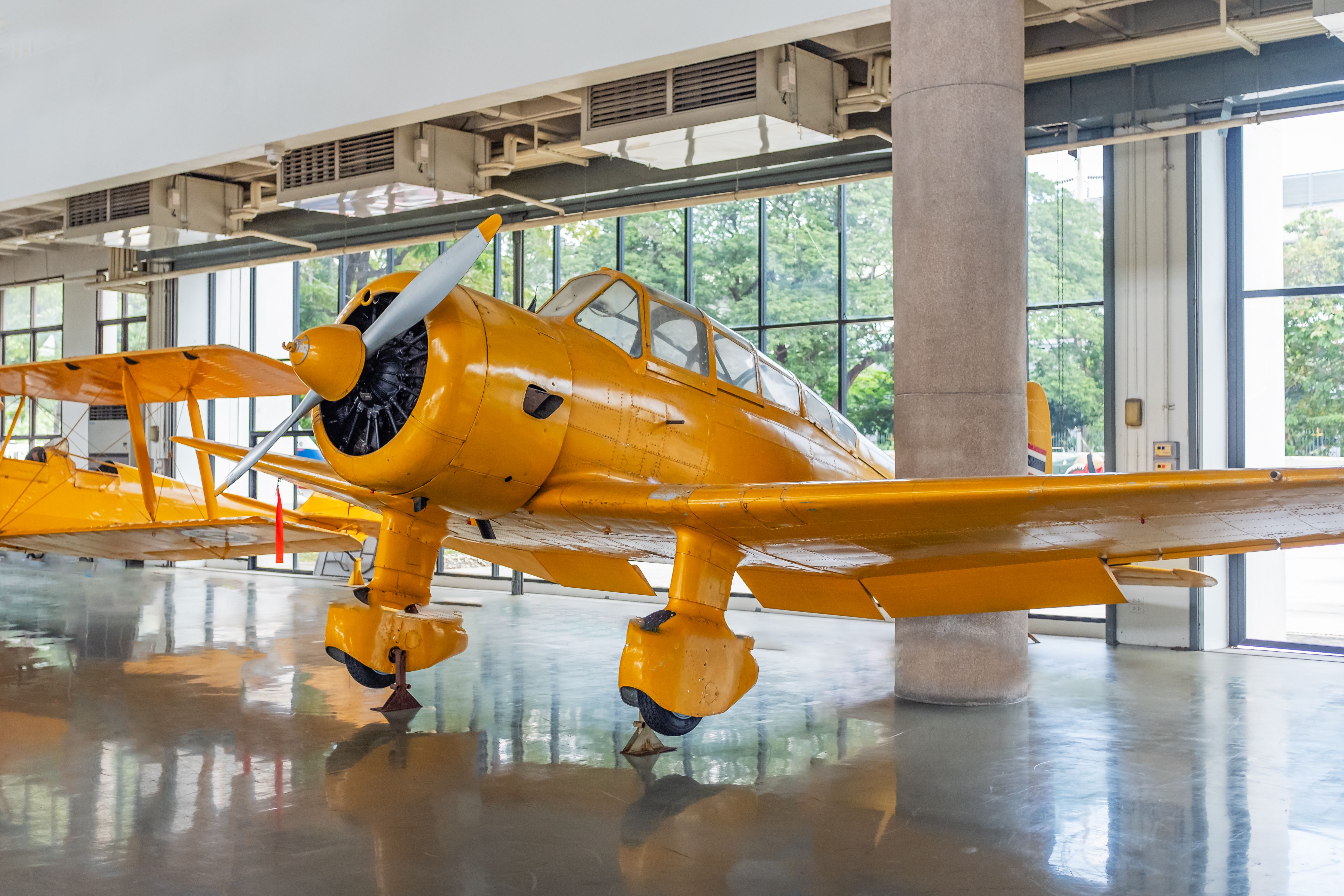 Vintage Yellow Aircraft Display in Museum · Free Stock Photo
