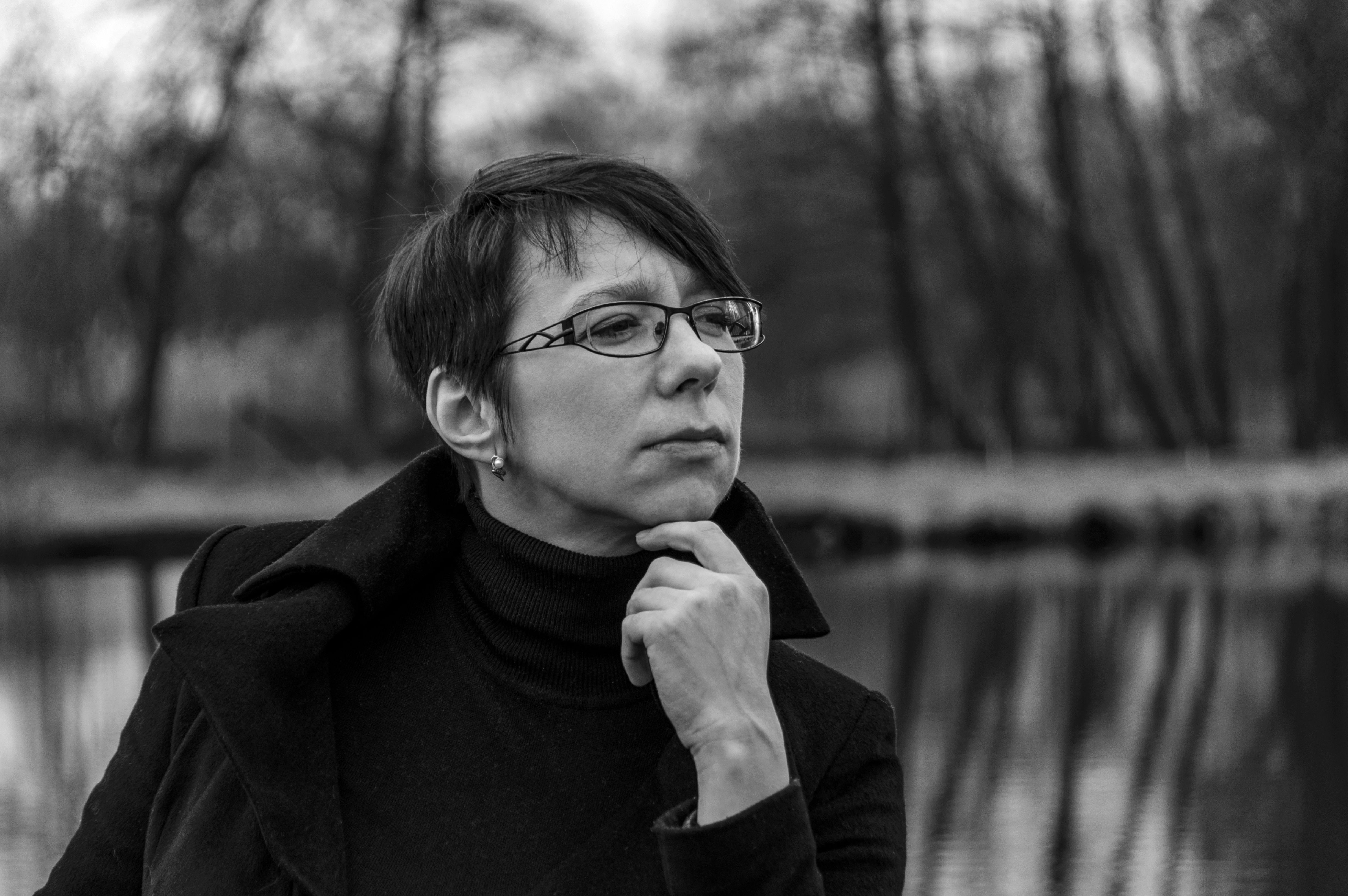 Black and White Portrait of a Reflective Woman Outdoors · Free Stock Photo