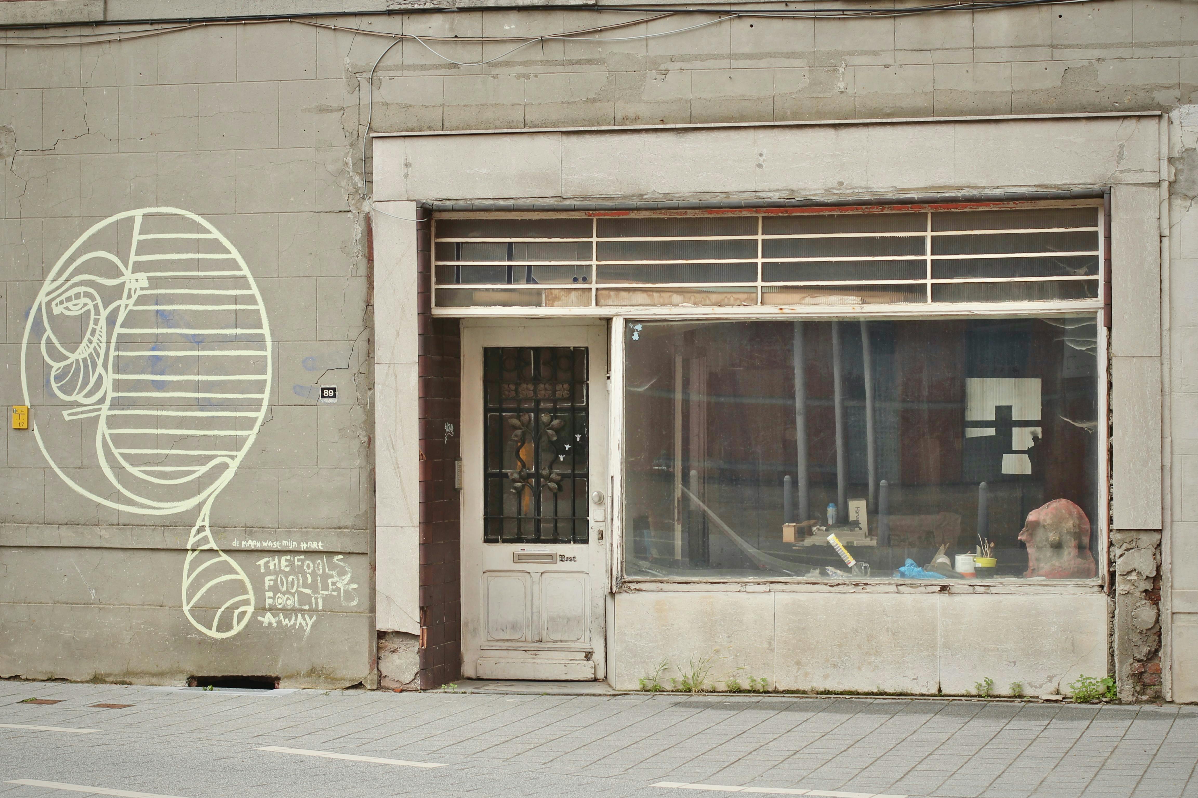 Urban Street Art on Abandoned Building Frontage · Free Stock Photo