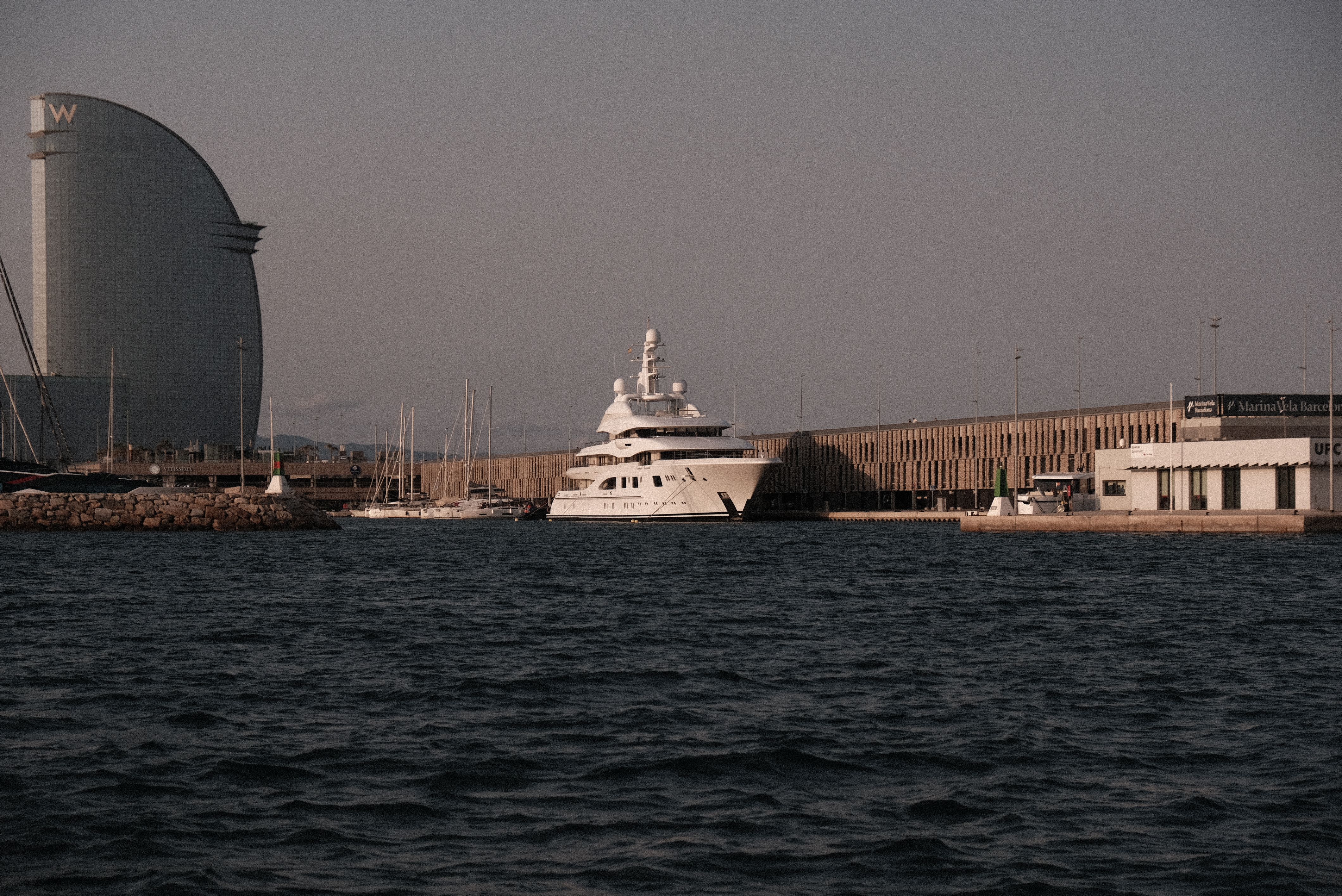 Luxury Yacht at Barcelona Port Vell at Sunset · Free Stock Photo