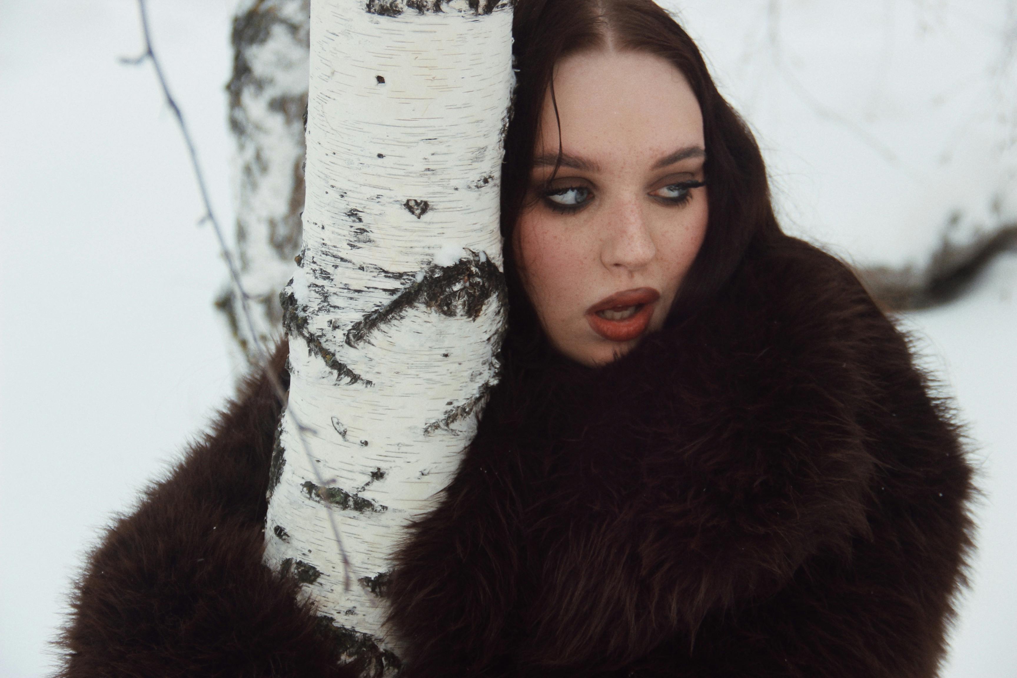 Woman in Fur Coat Embracing Birch Tree in Winter · Free Stock Photo