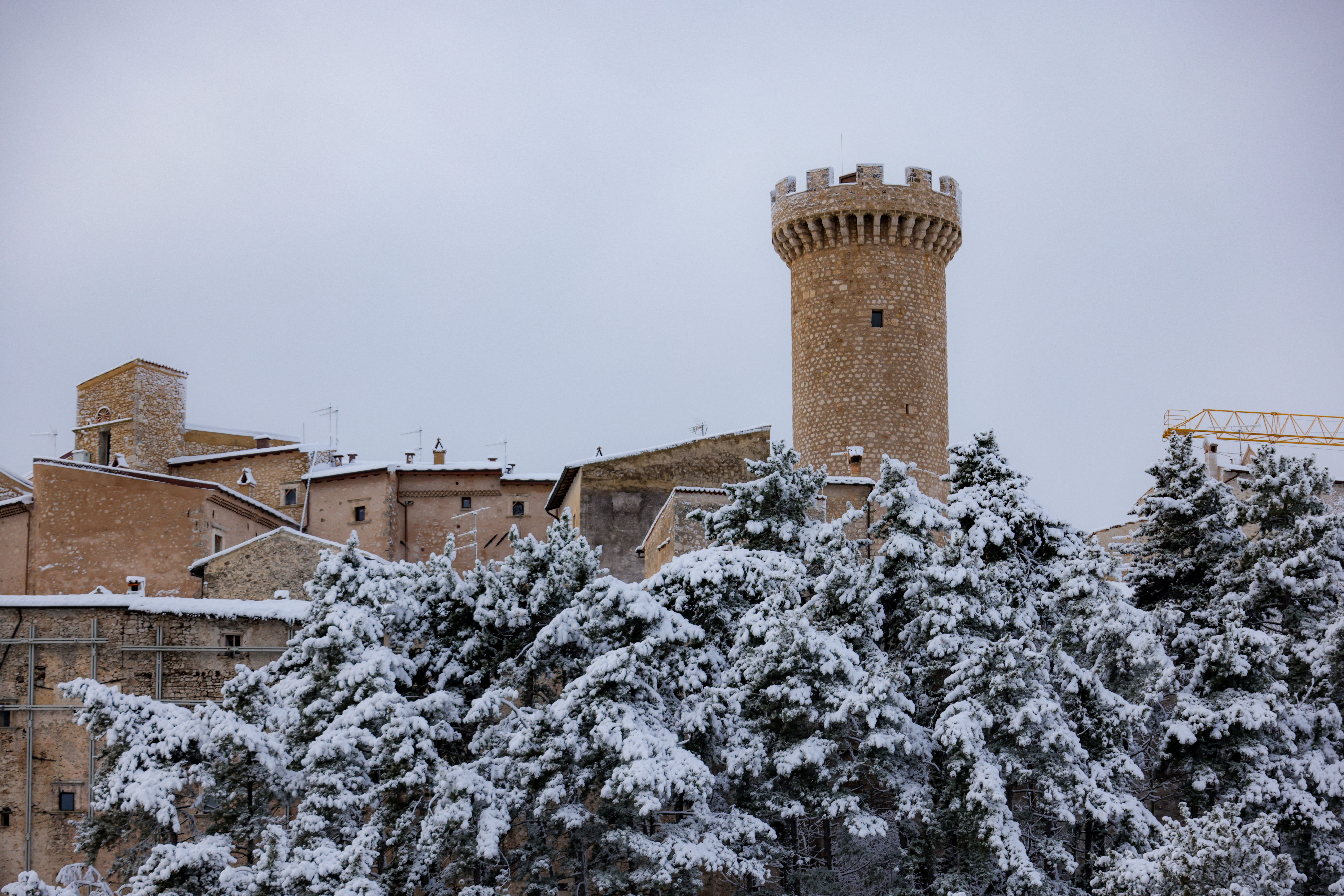 Snow-Covered Italian Village with Medieval Tower · Free Stock Photo