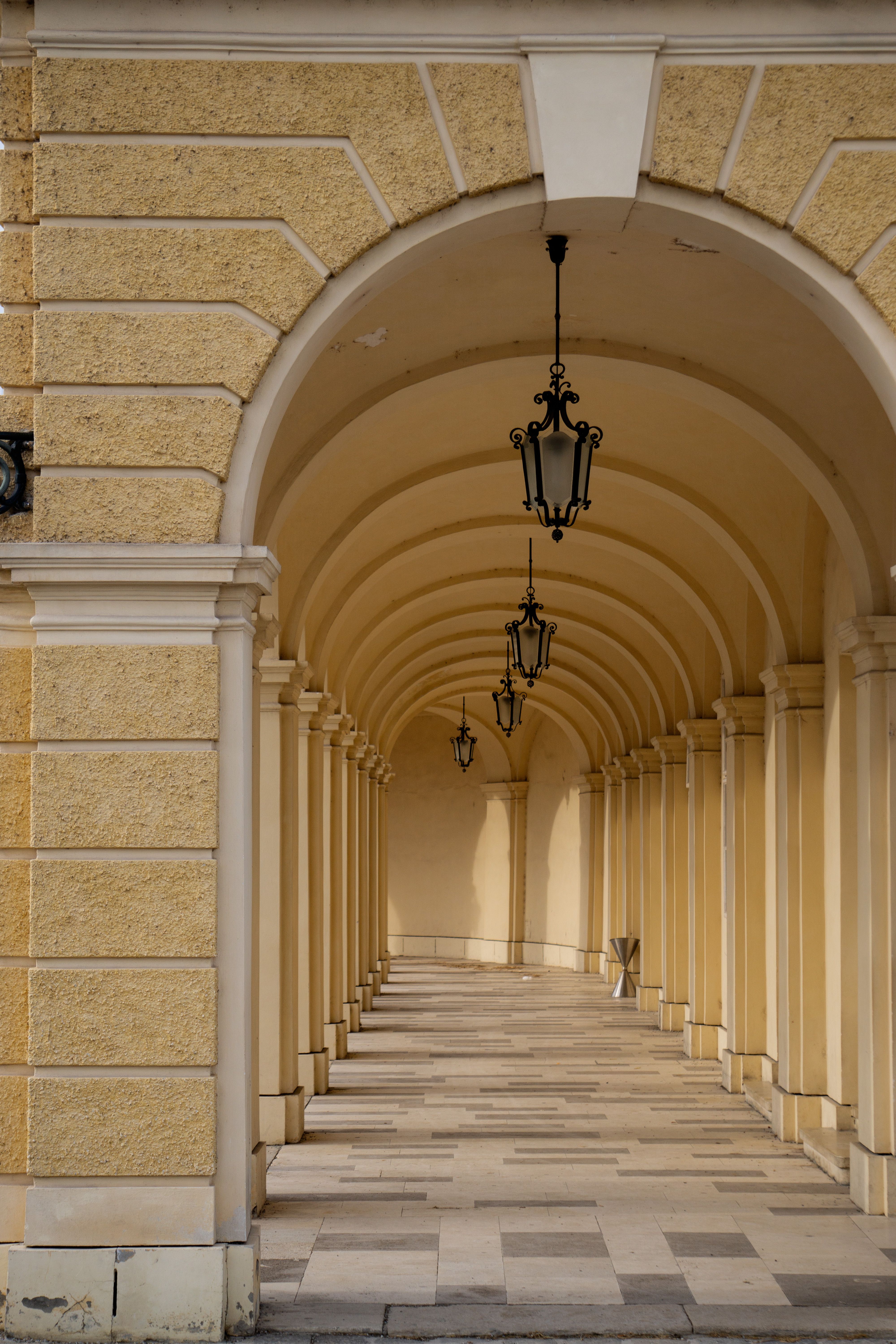 Elegant Arched Corridor with Vintage Lanterns · Free Stock Photo
