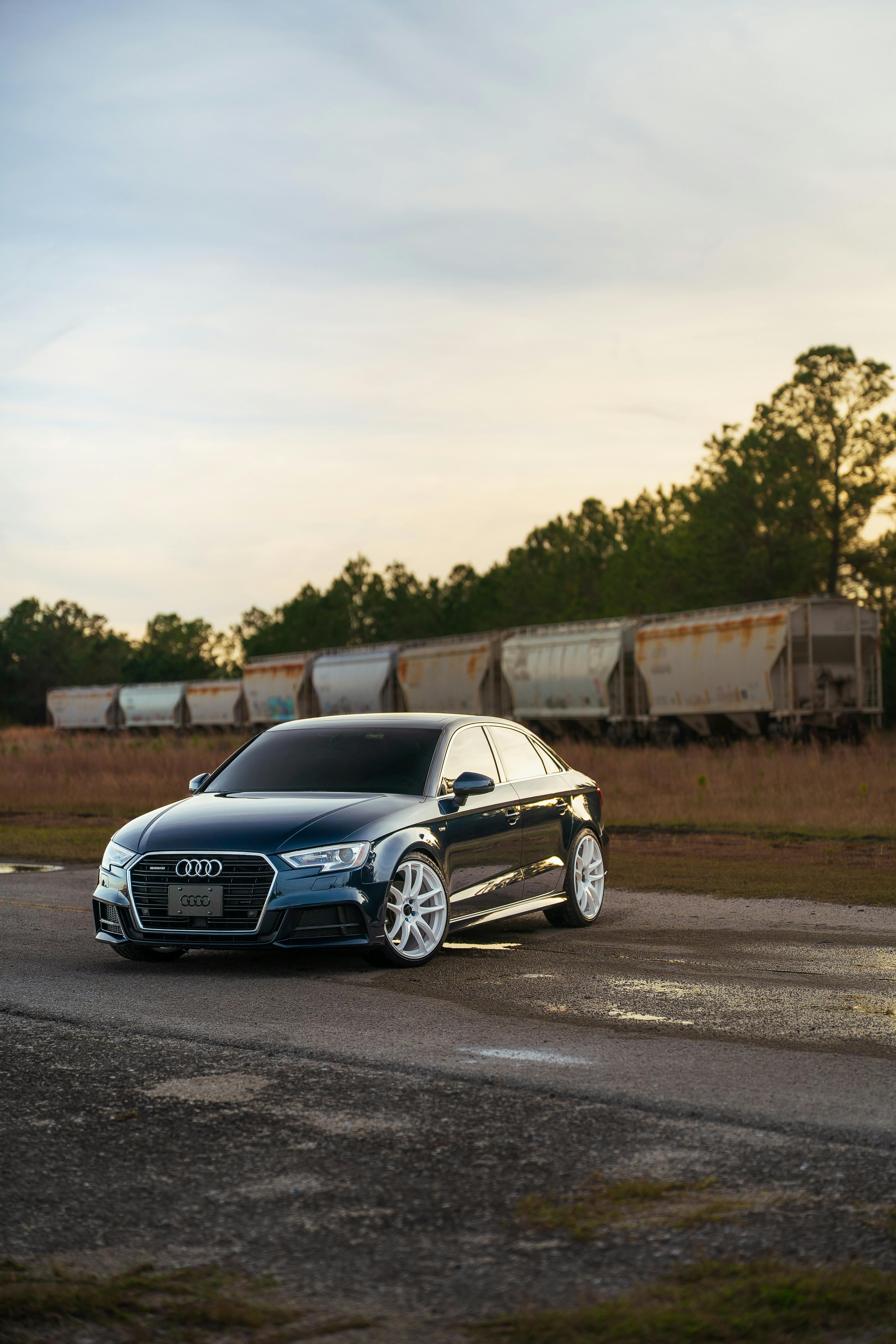 Luxury Sedan in Scenic Outdoor Setting at Sunset · Free Stock Photo