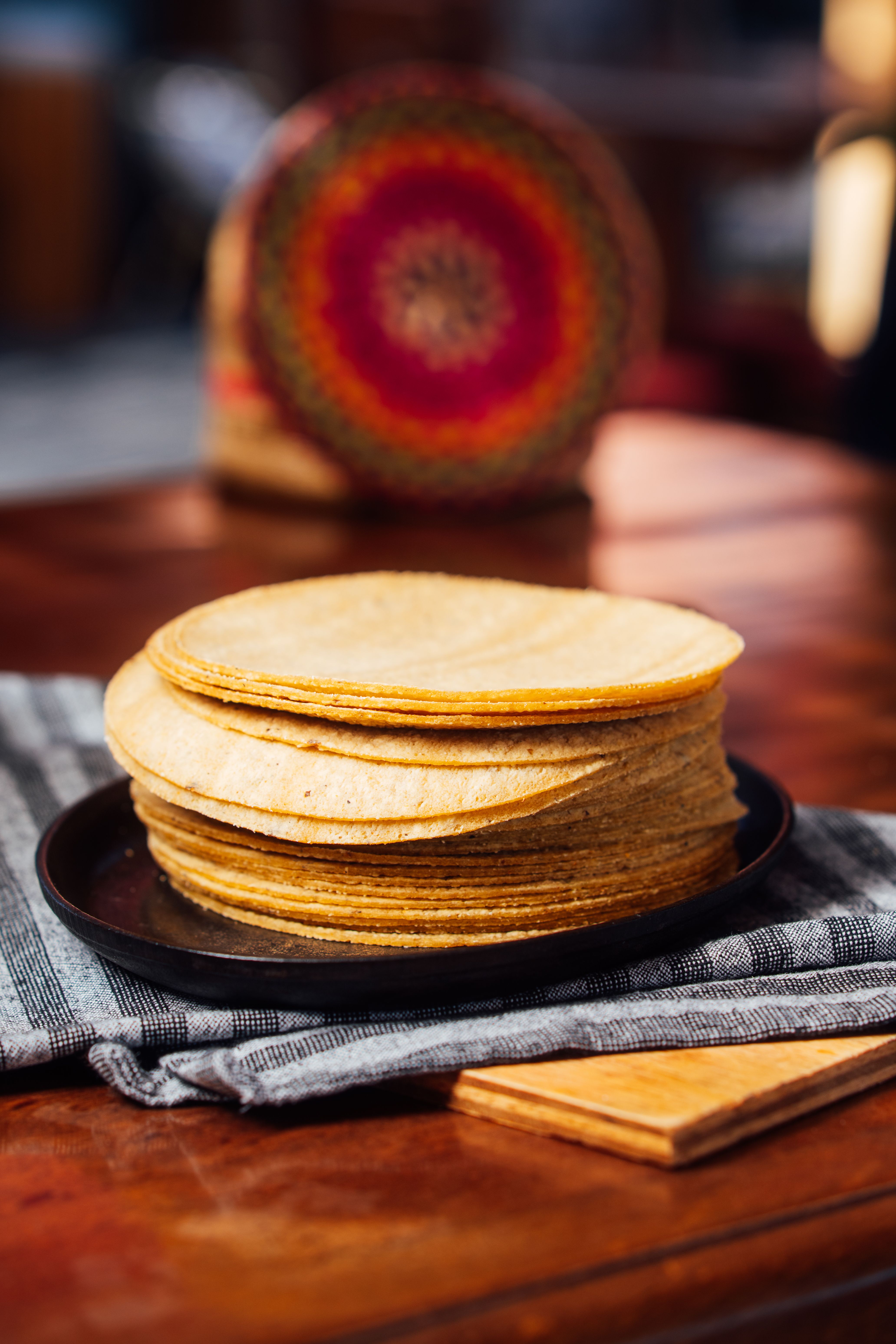 Stack of Corn Tortillas on Rustic Table · Free Stock Photo